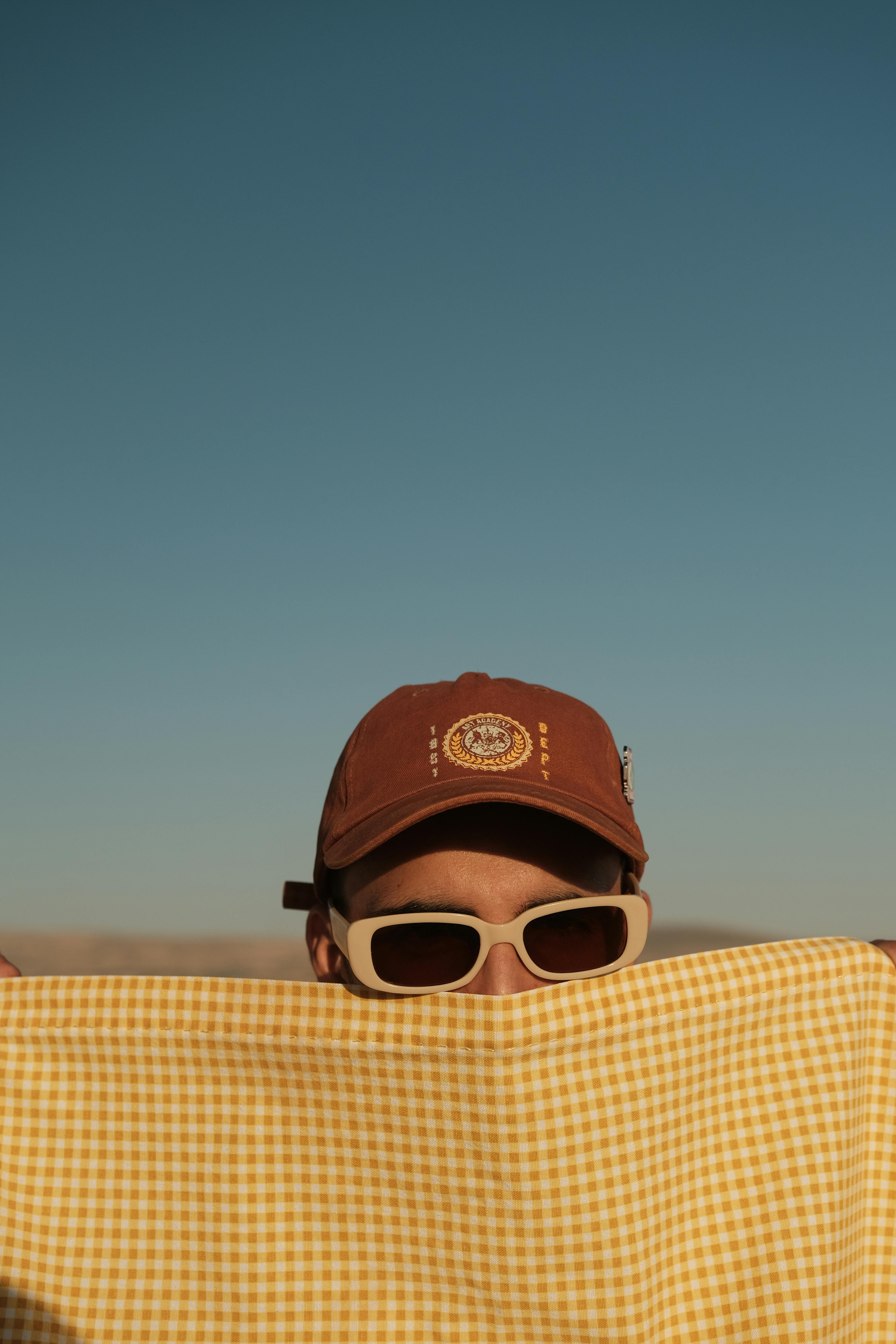 Man in Cap and Sunglasses behind Fabric · Free Stock Photo