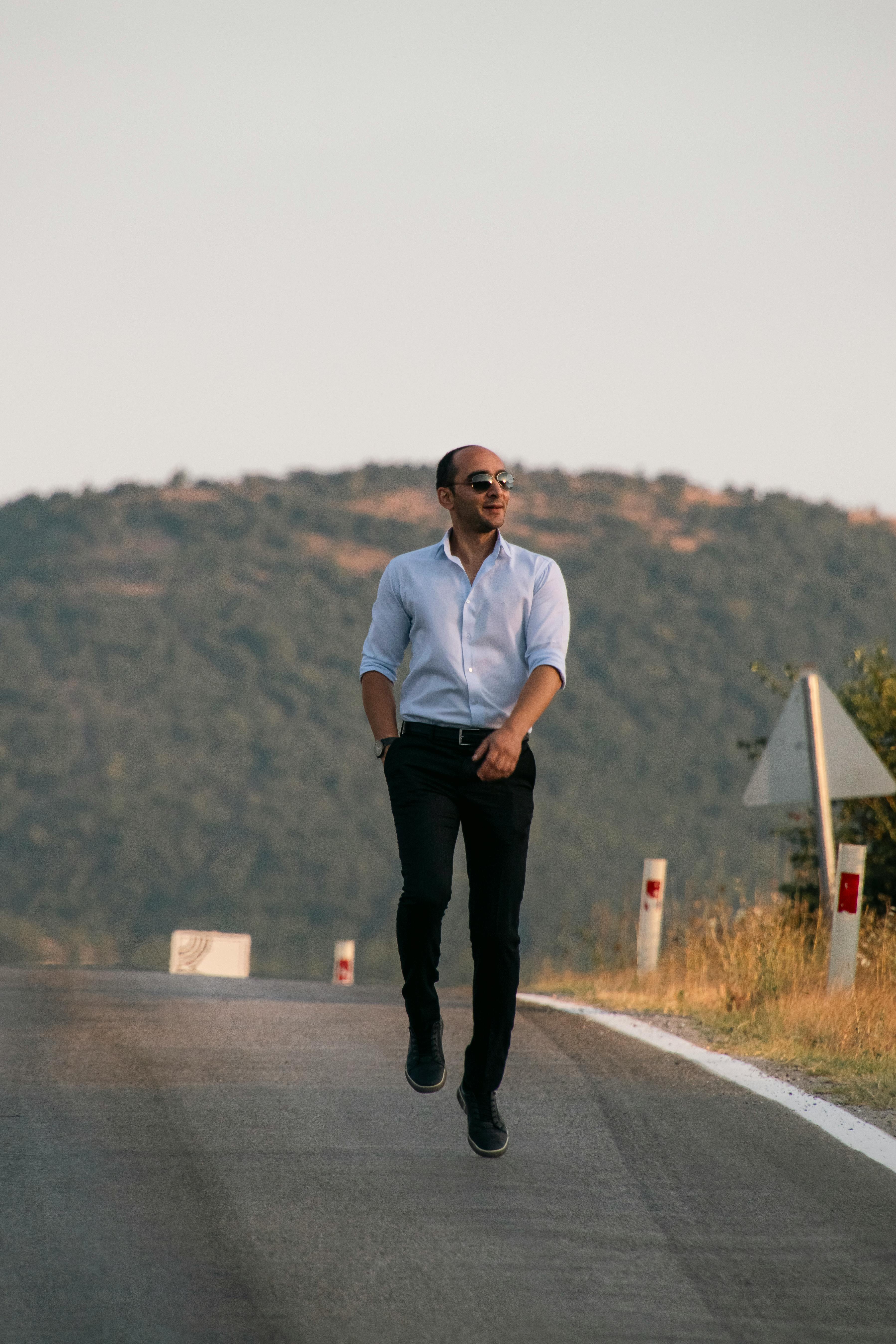 Elegant Man Walking on a Road · Free Stock Photo