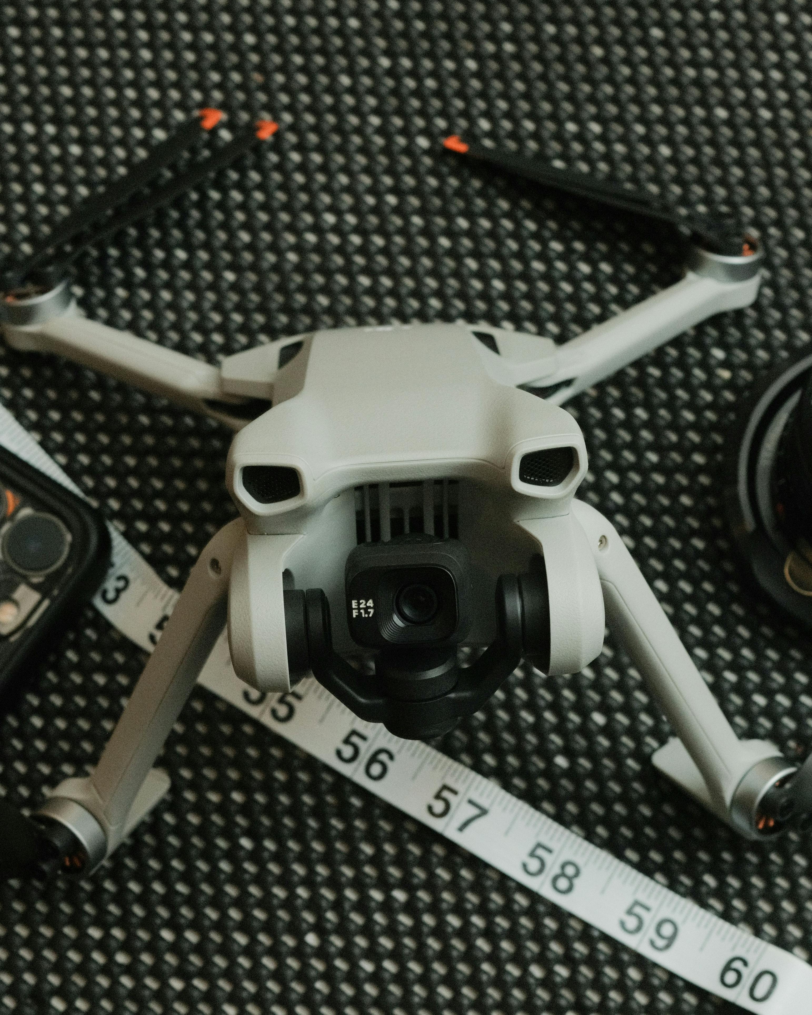 Drone and Measuring Tape Set on Table · Free Stock Photo
