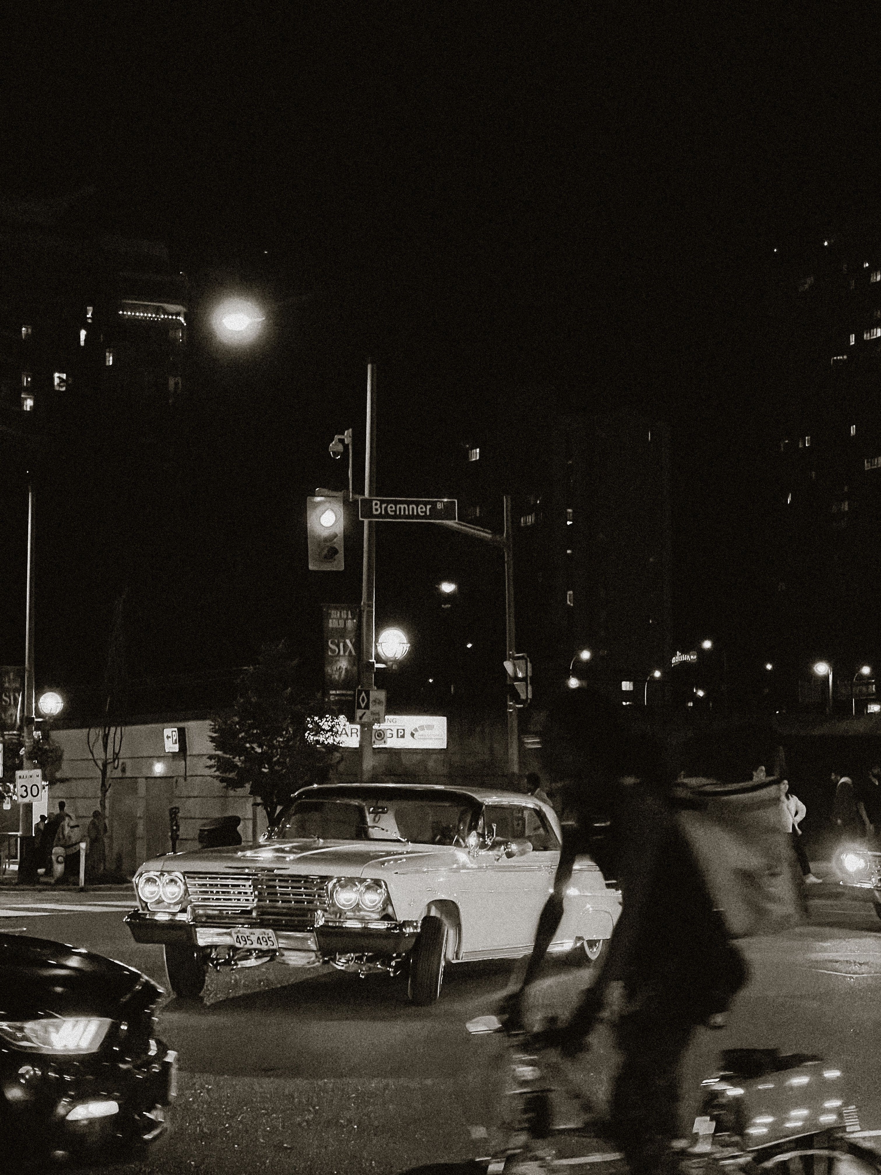 Vintage Car Riding on a Street in Black and White · Free Stock Photo