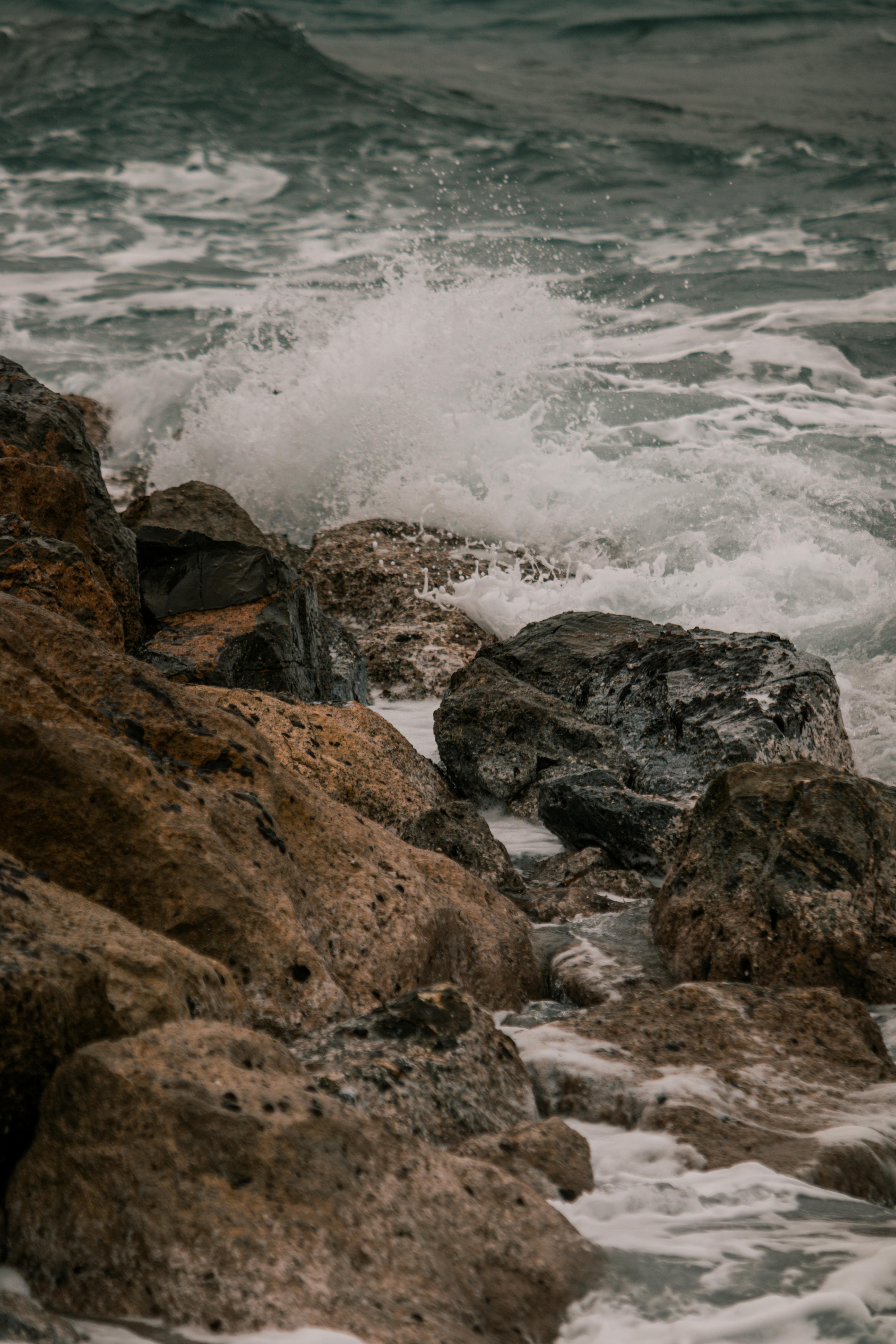 Foamy Surf Waves Splashing on Rocky Seashore · Free Stock Photo