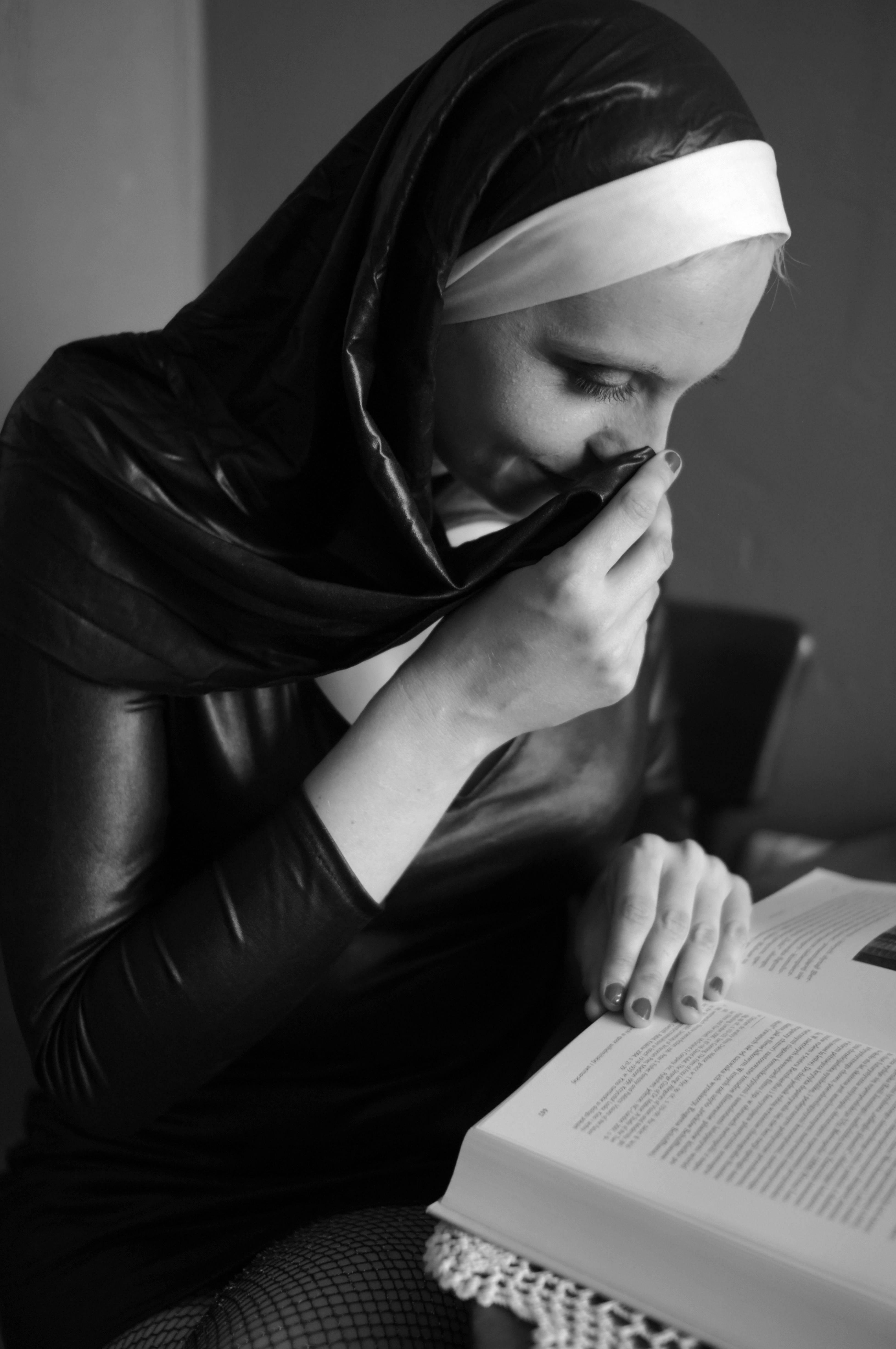 Black and White Photo of Woman Wearing Leather Nun Costume Reading Book ...