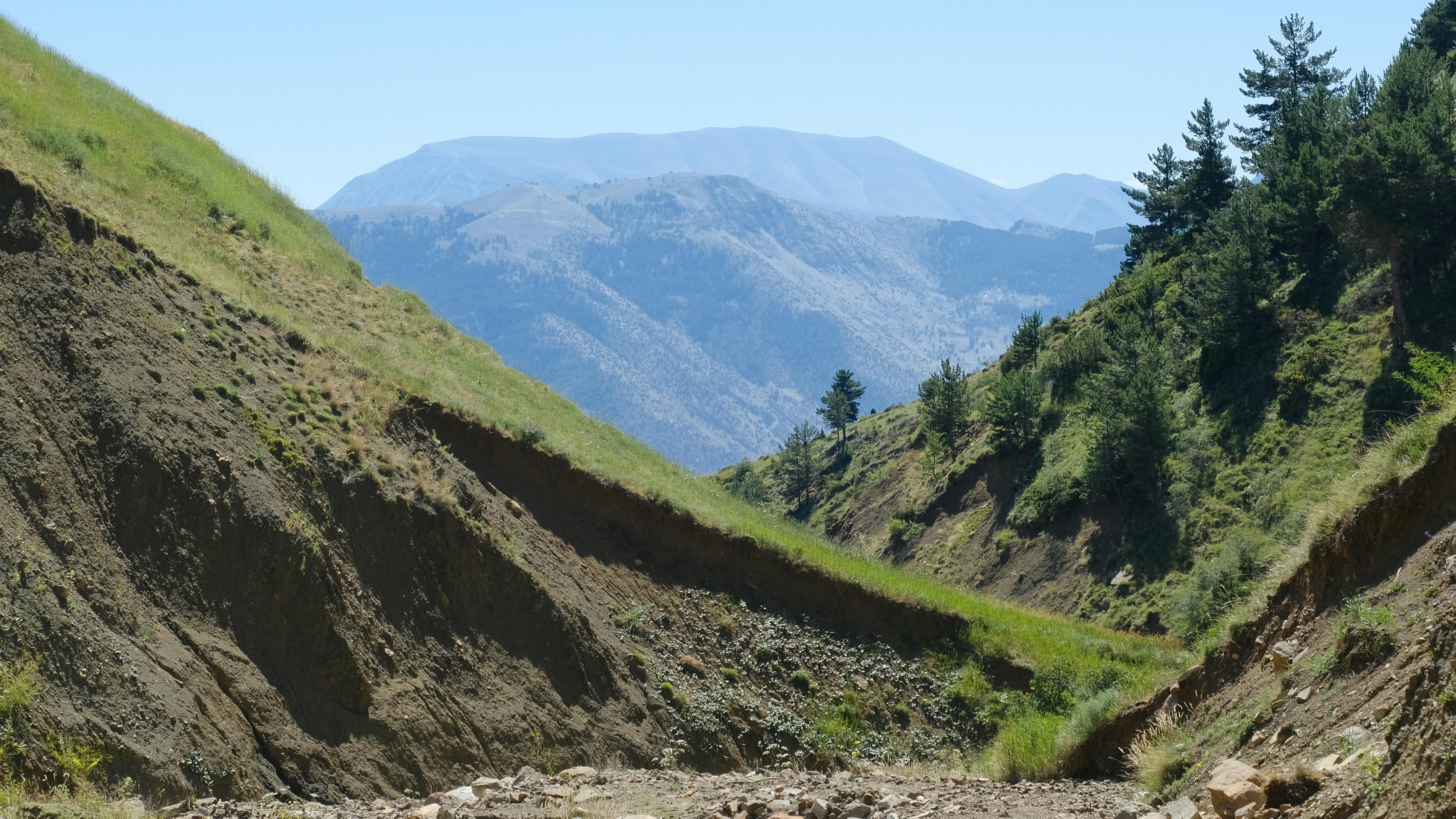 Grassy Hill Slope in Mountains · Free Stock Photo