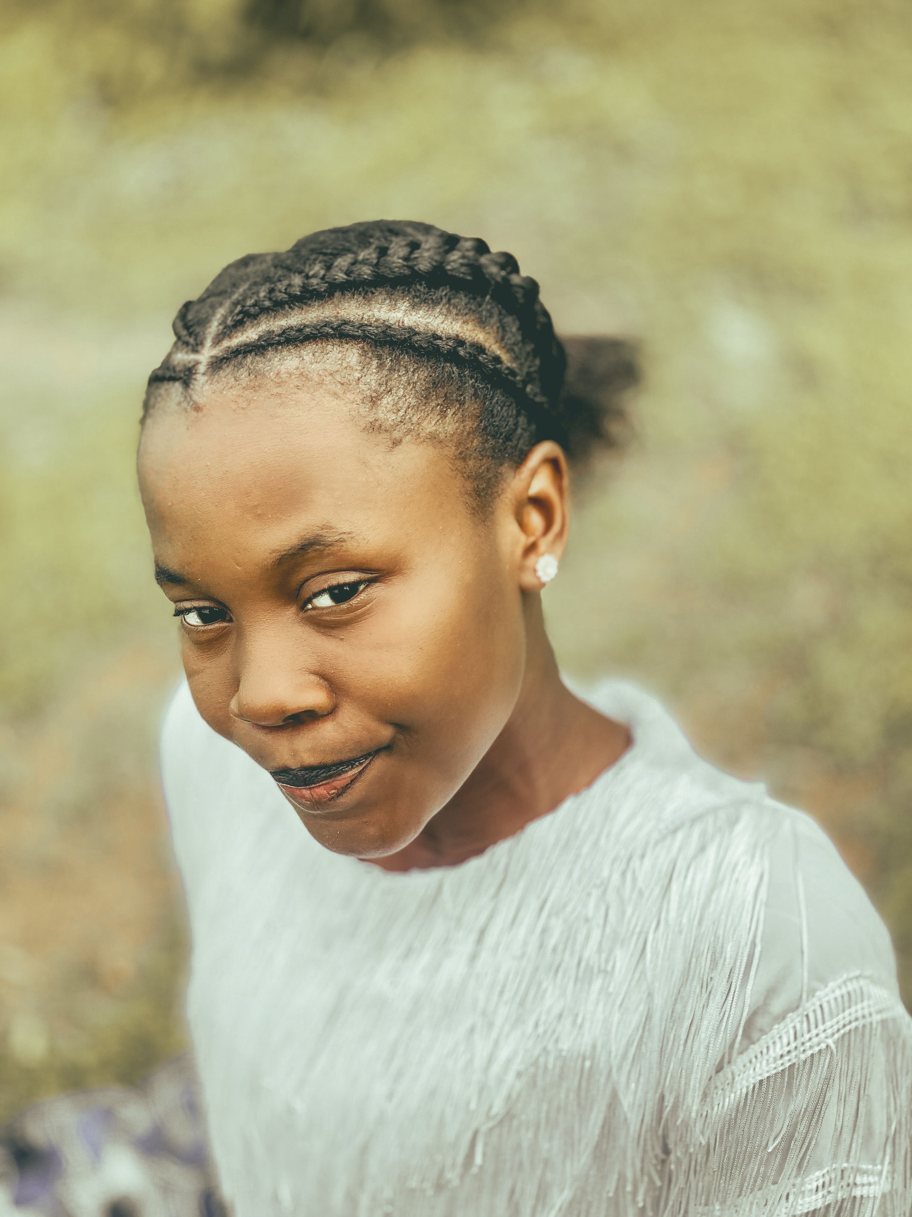 Woman with Braids Posing in White Dress on a Lawn · Free Stock Photo