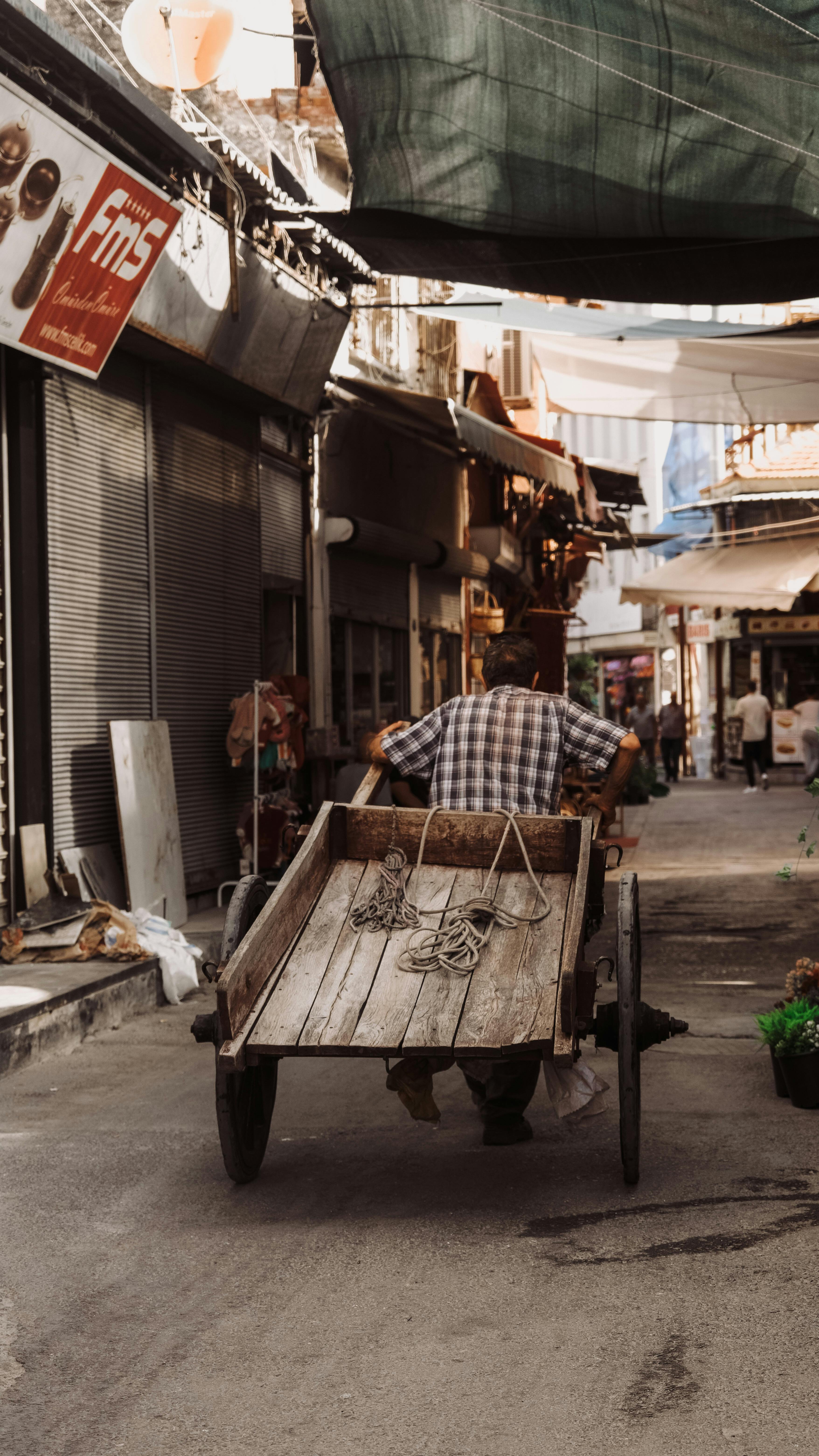 Man Pulling Trolley on Street · Free Stock Photo
