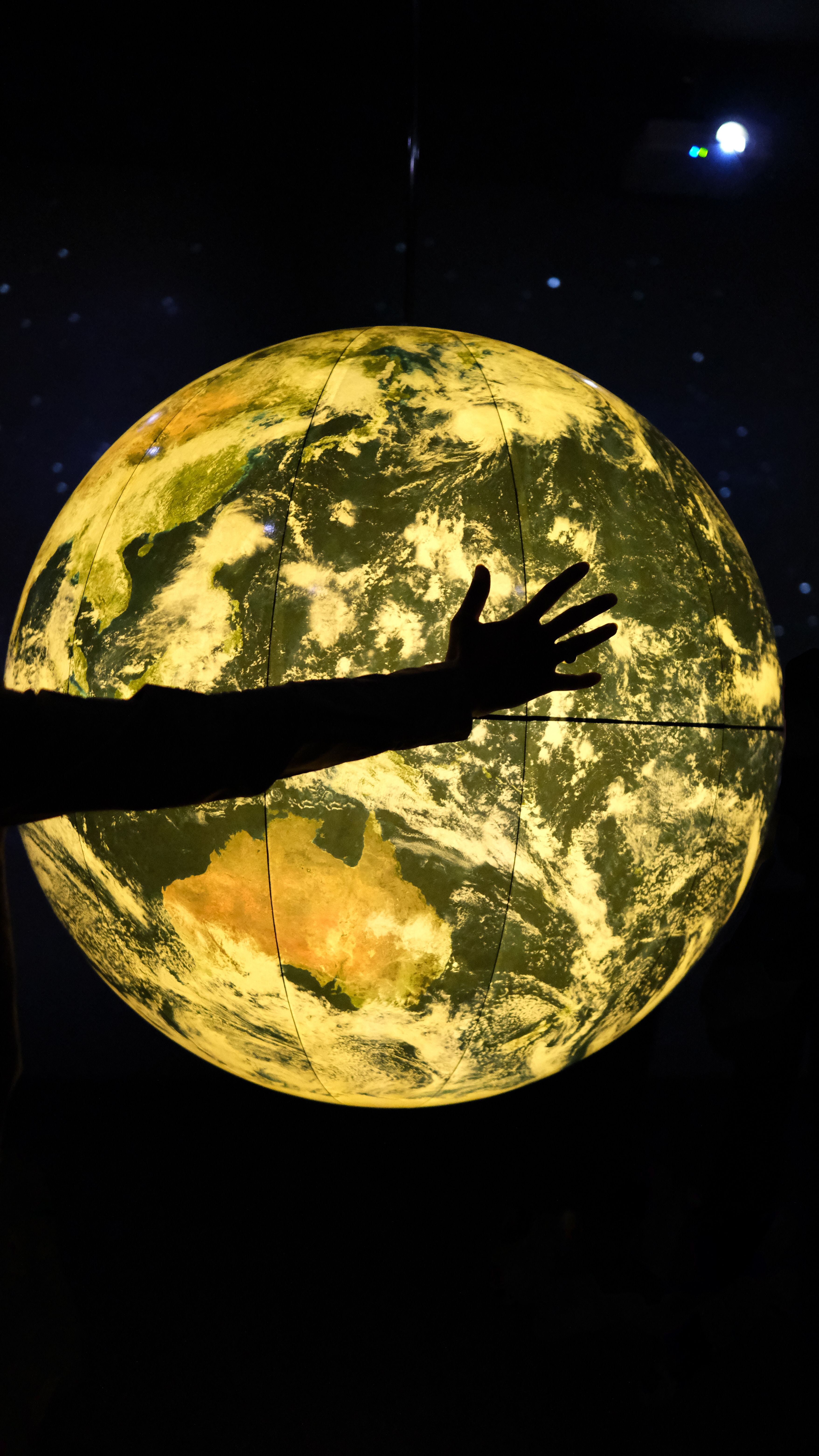 Hand over Globe Model · Free Stock Photo