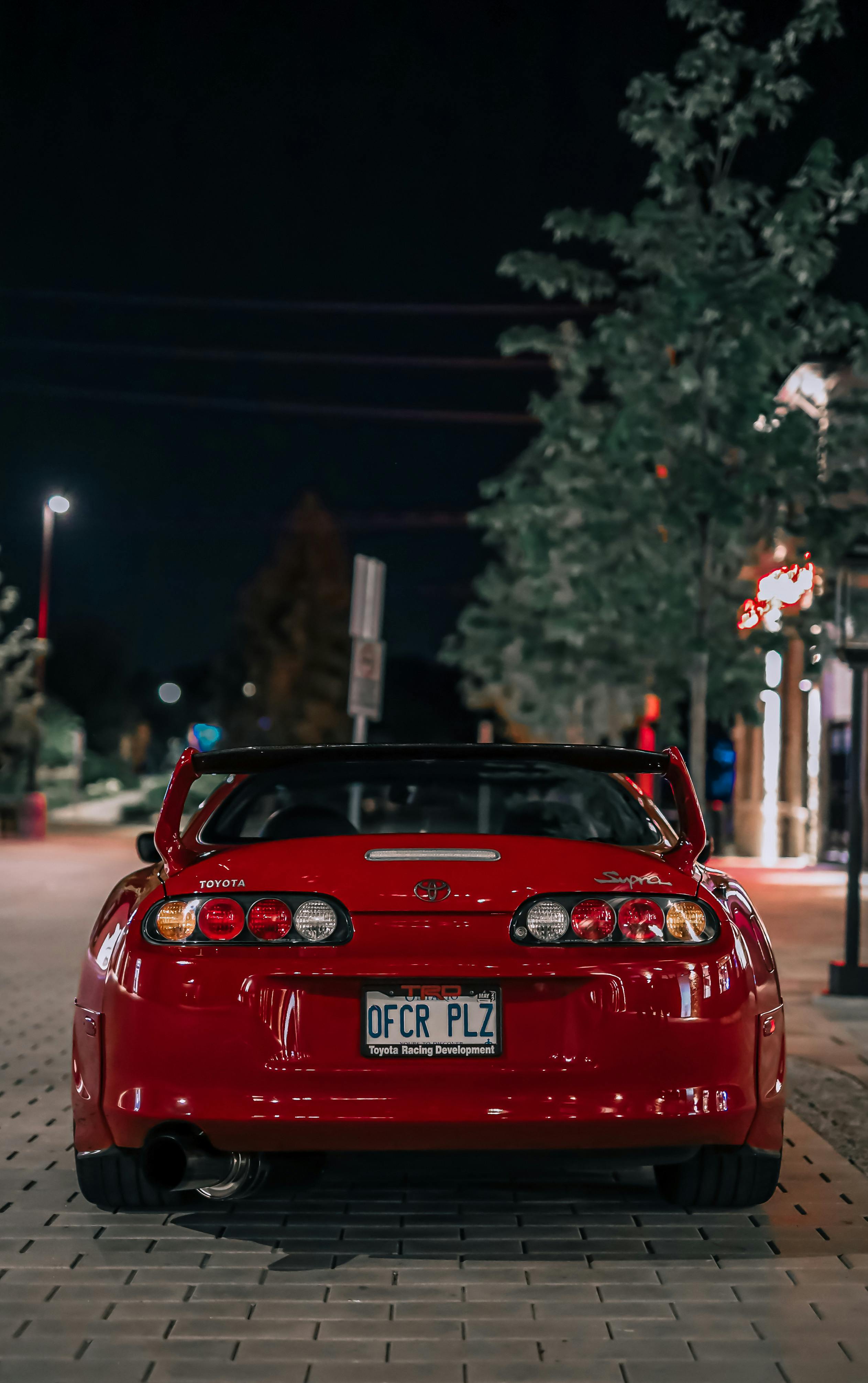 Back View of a Red Sports Car at Night · Free Stock Photo