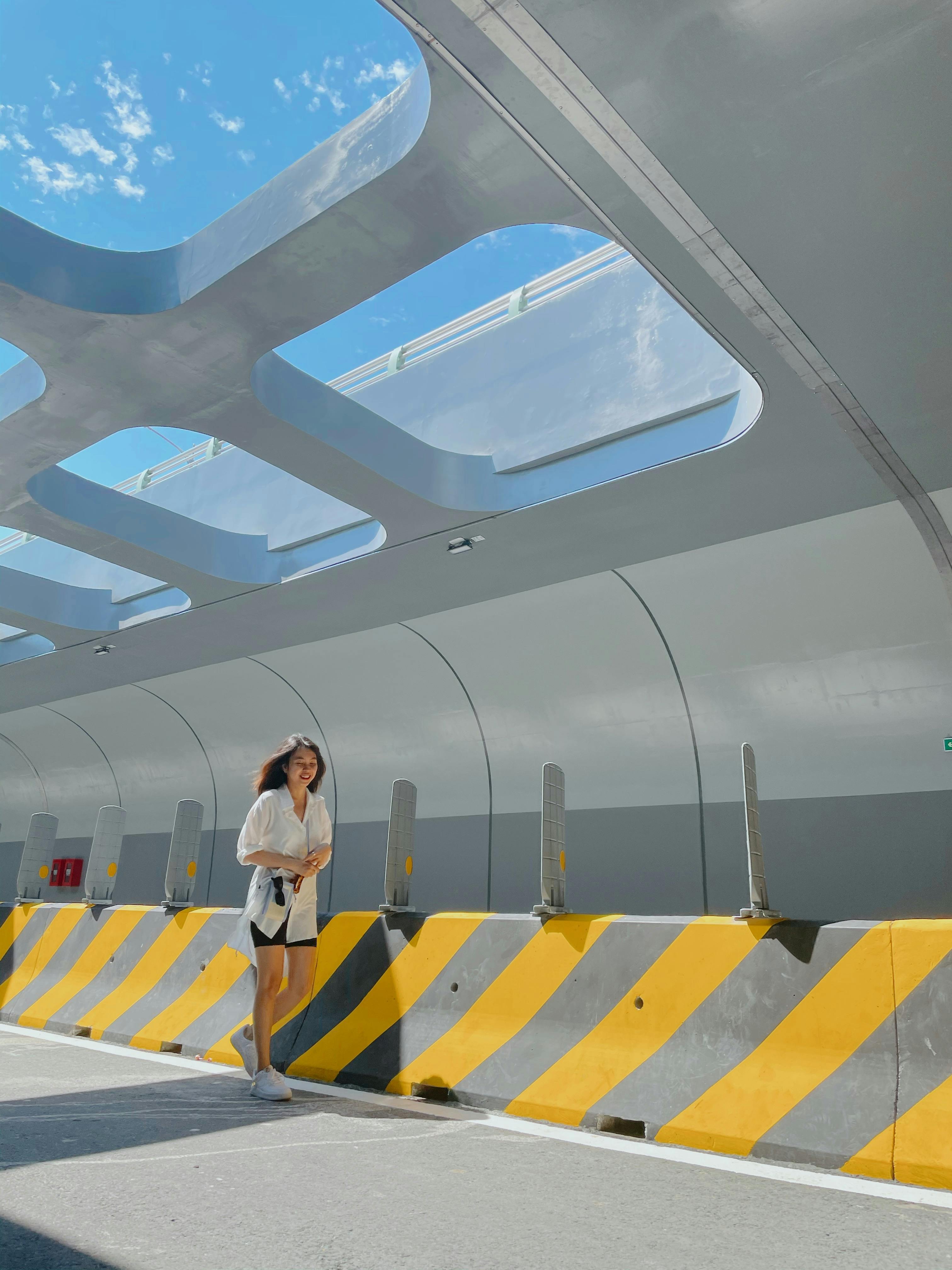 Woman in Shirt Walking under Windows on Ceiling · Free Stock Photo
