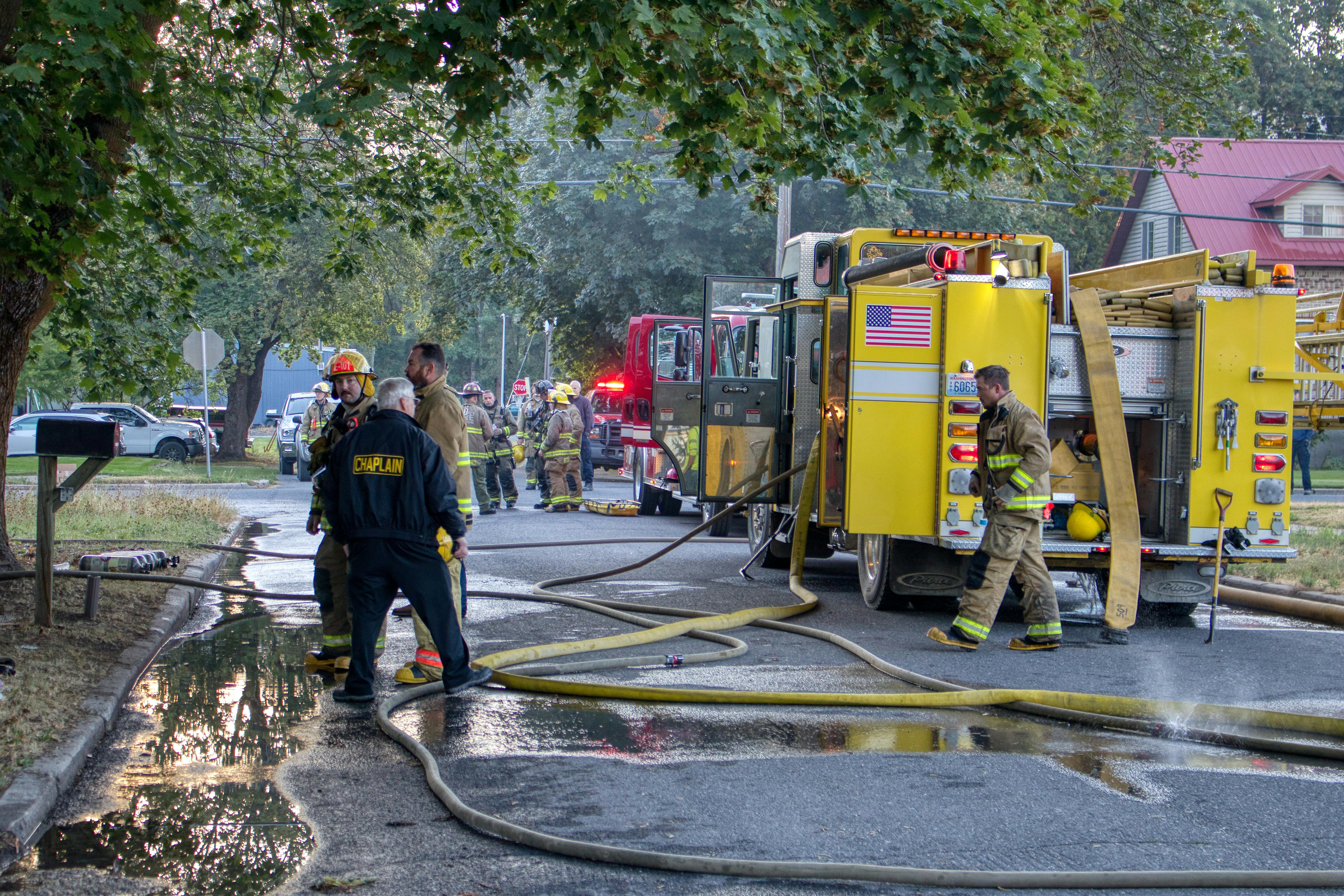 Firefighters Walking on a Street near a Firetruck and Fire Hoses · Free ...