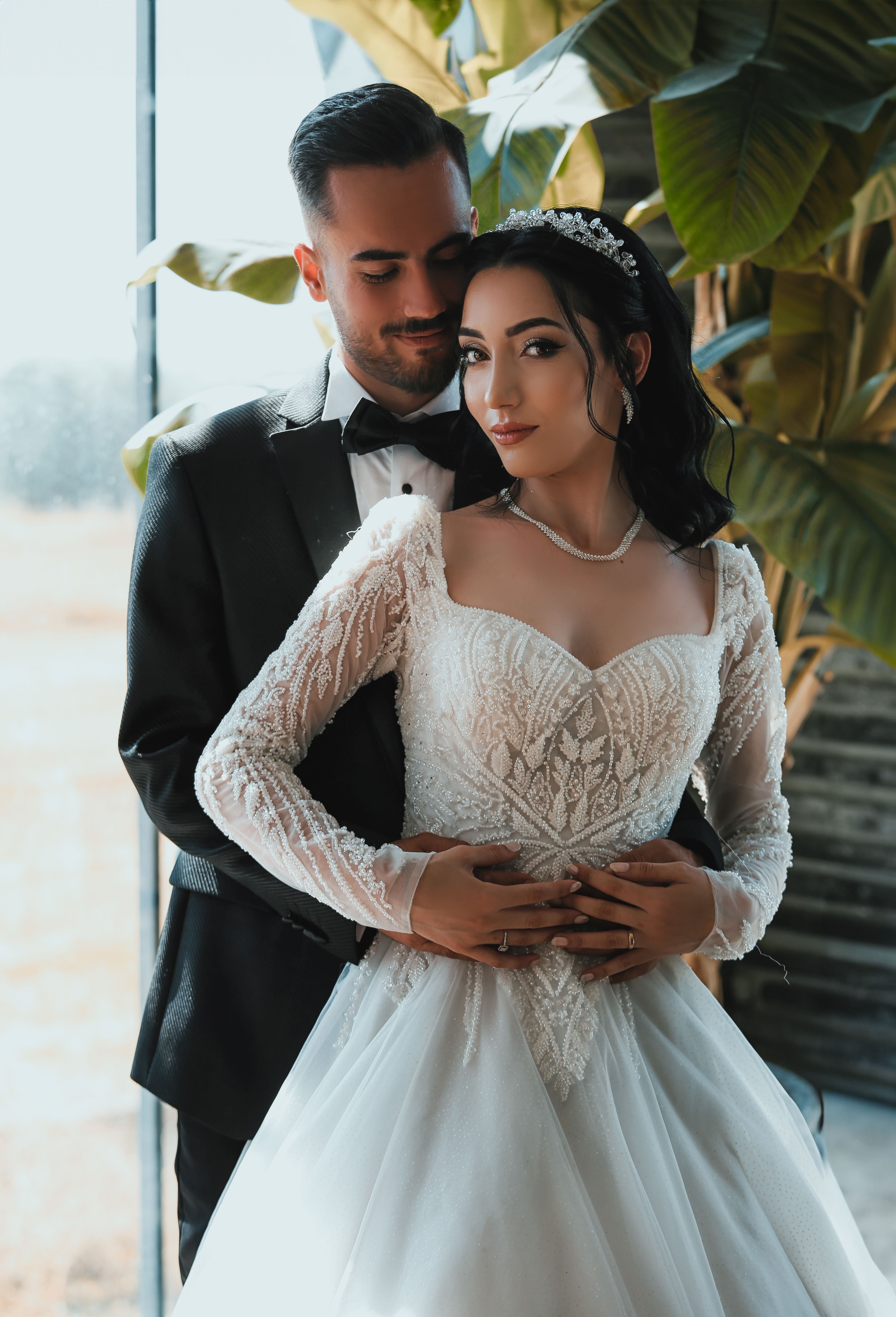 Bridegroom Embracing his Bride from Behind · Free Stock Photo