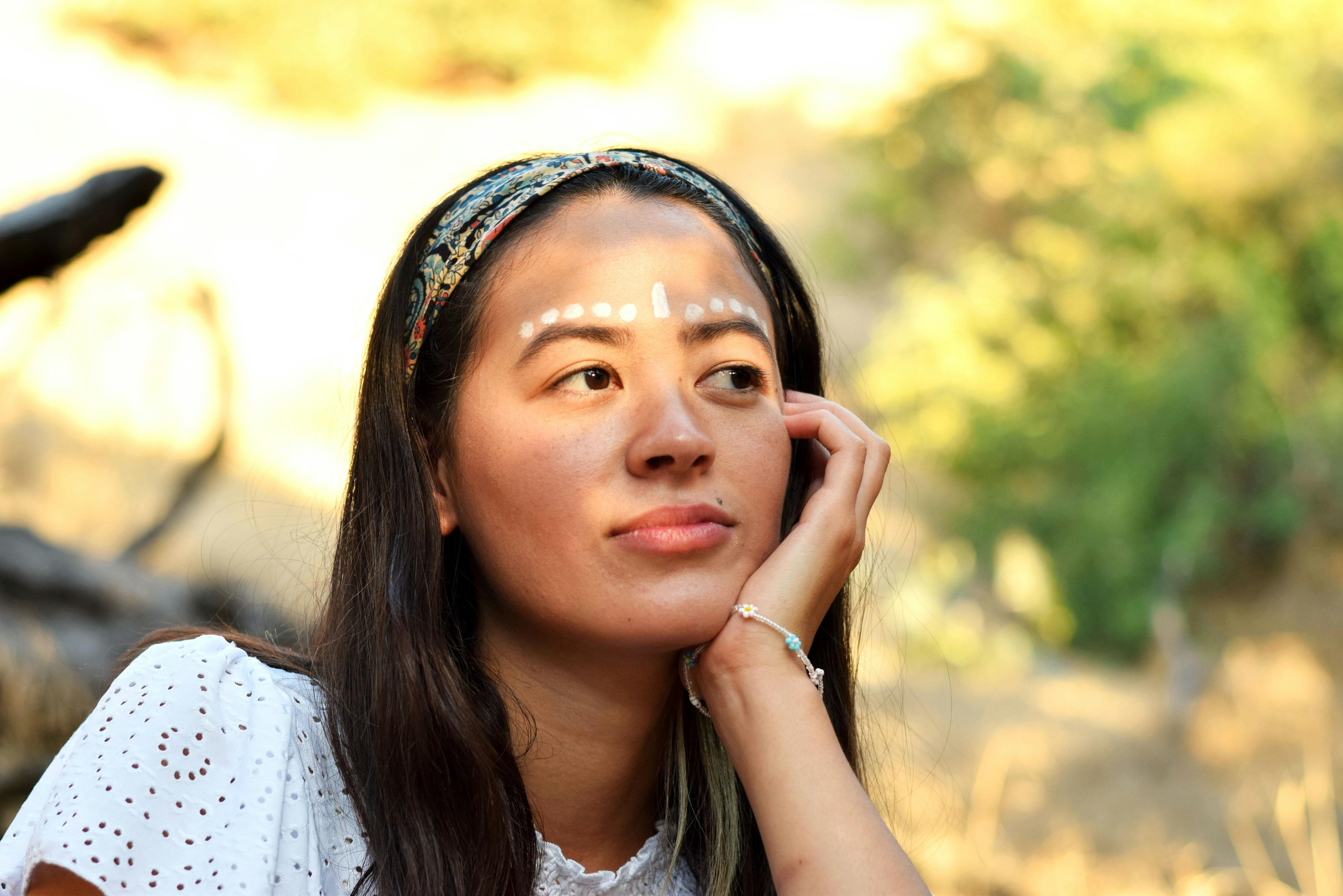 Young Brunette Woman with Face Paint on her Forehead · Free Stock Photo
