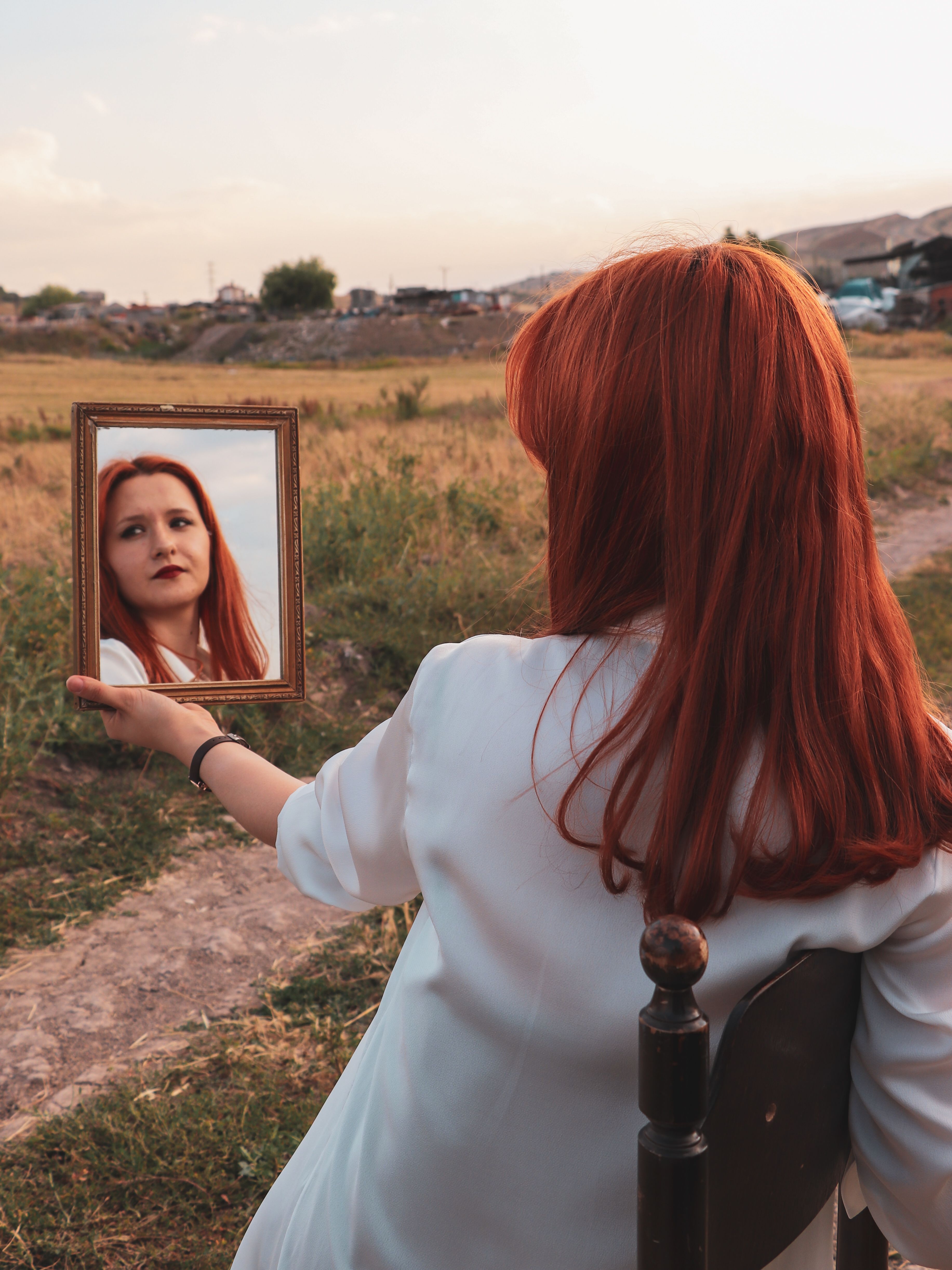 Redhead Woman Standing on Dirt Road · Free Stock Photo