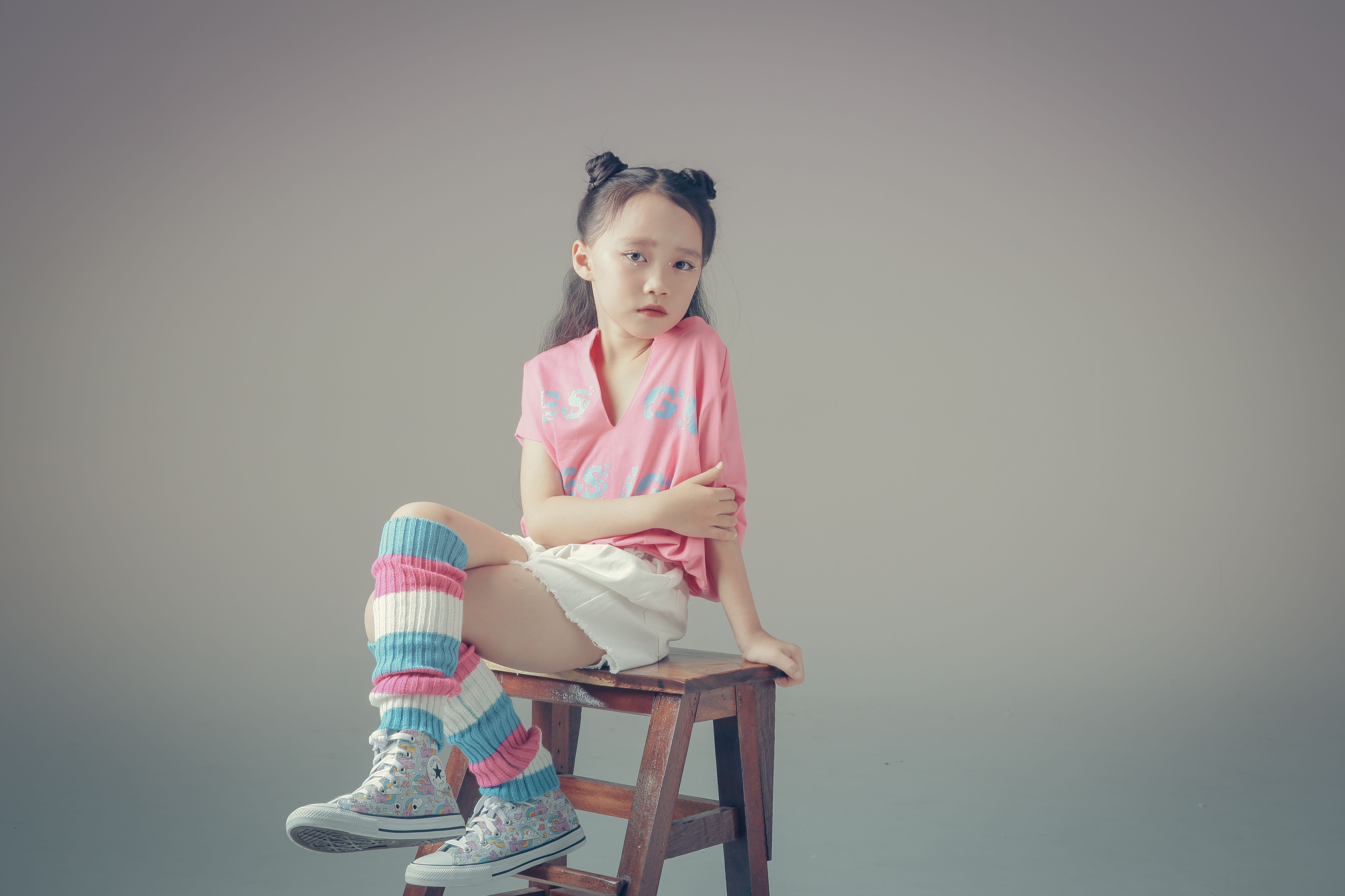 Girl in Colored Stockings Sits on Stool · Free Stock Photo