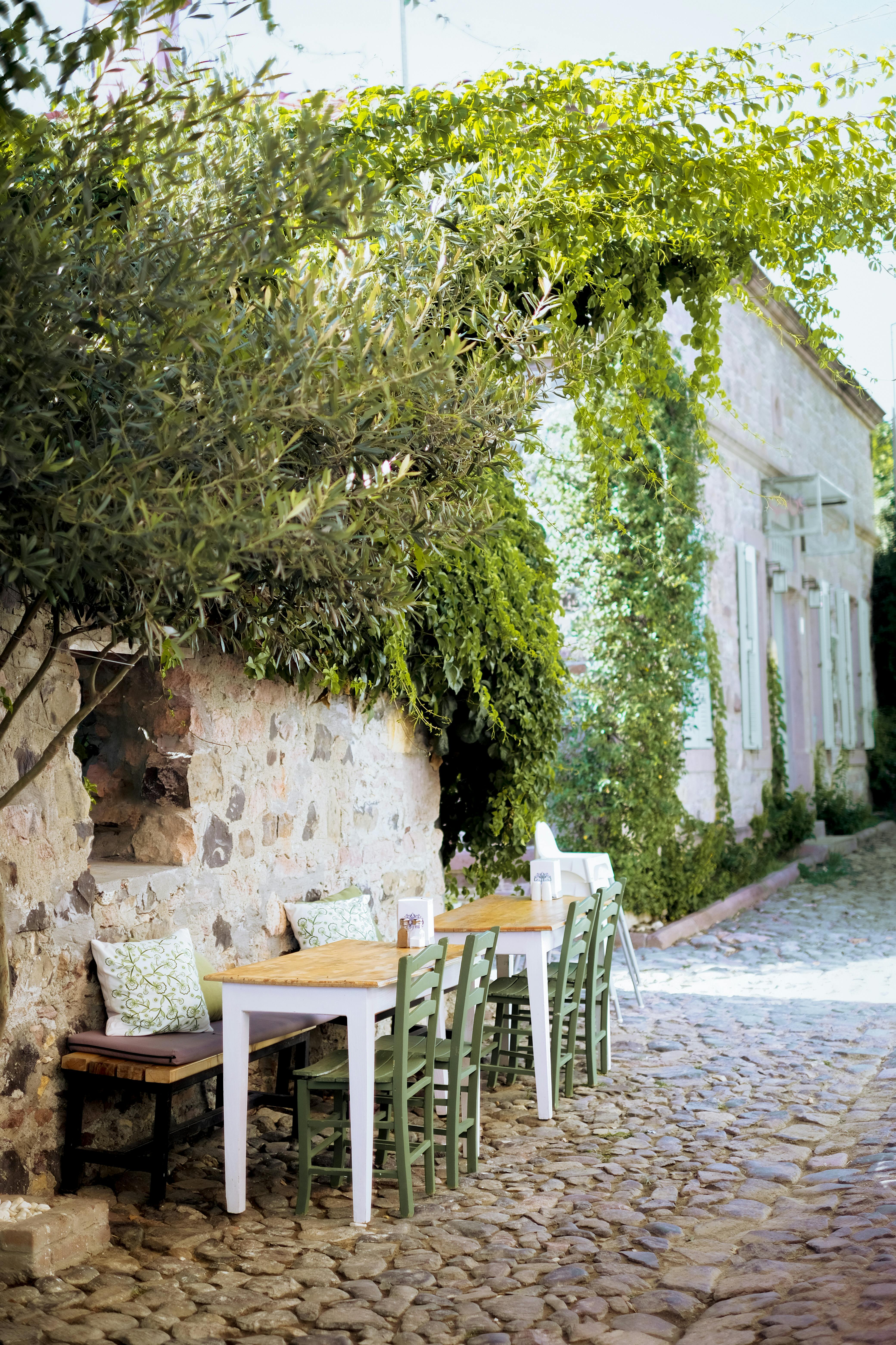Chairs and Tables Standing by a Wall on a Cobblestone Alley in a Town ...