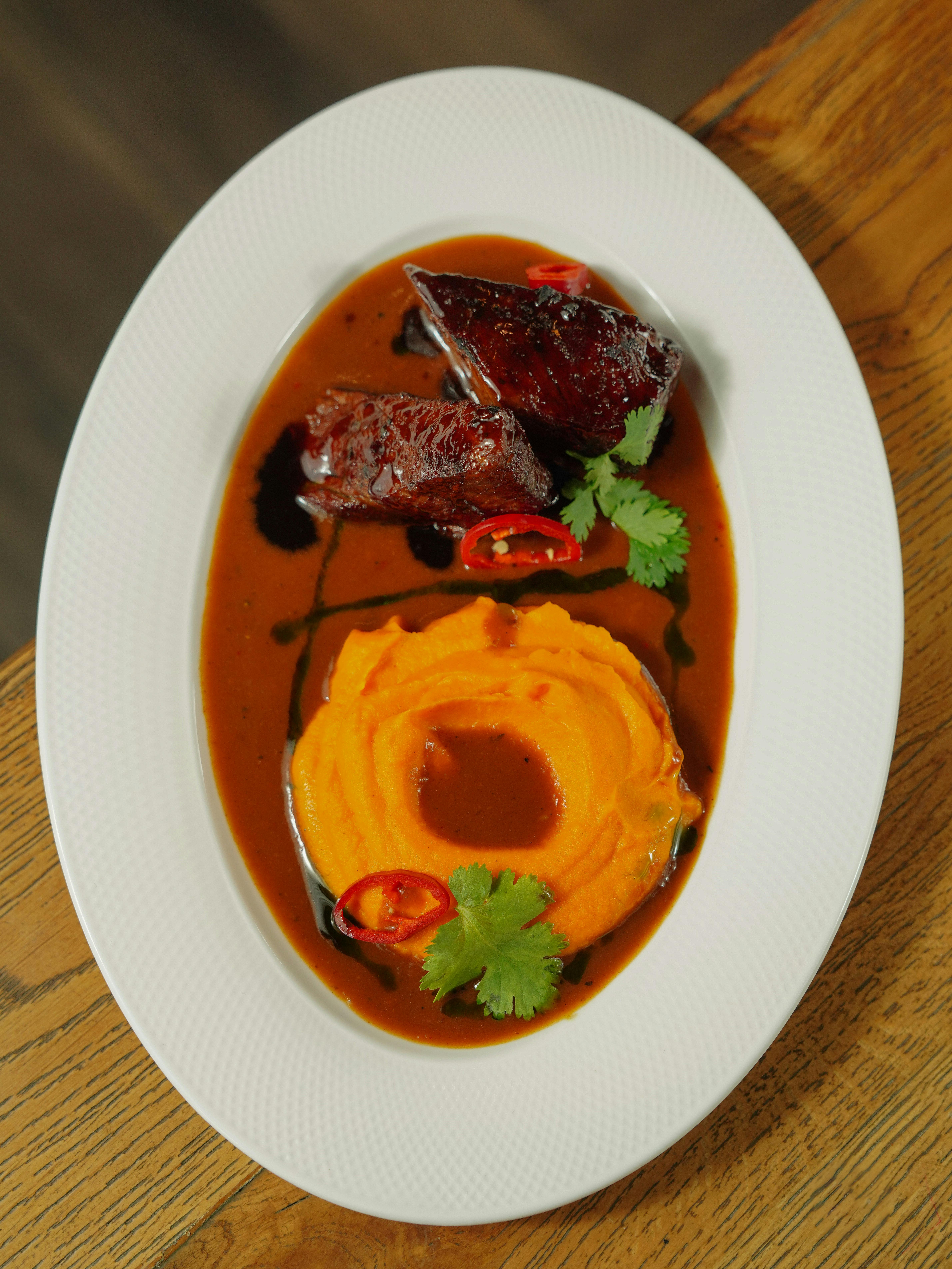 Plate of Meat with Sweet Potato Puree and a Sauce · Free Stock Photo