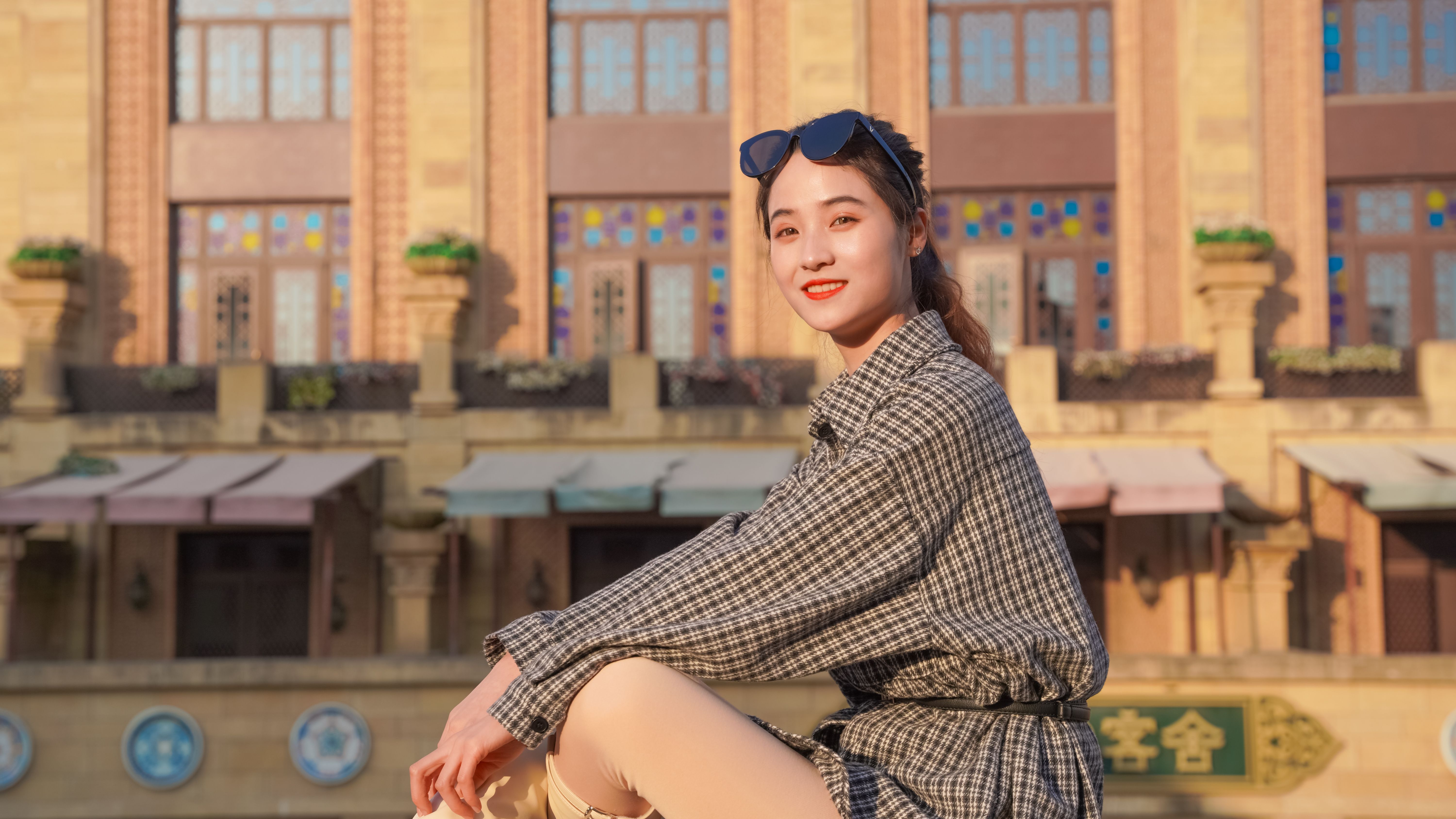Young Woman Sitting Outside in City and Smiling · Free Stock Photo
