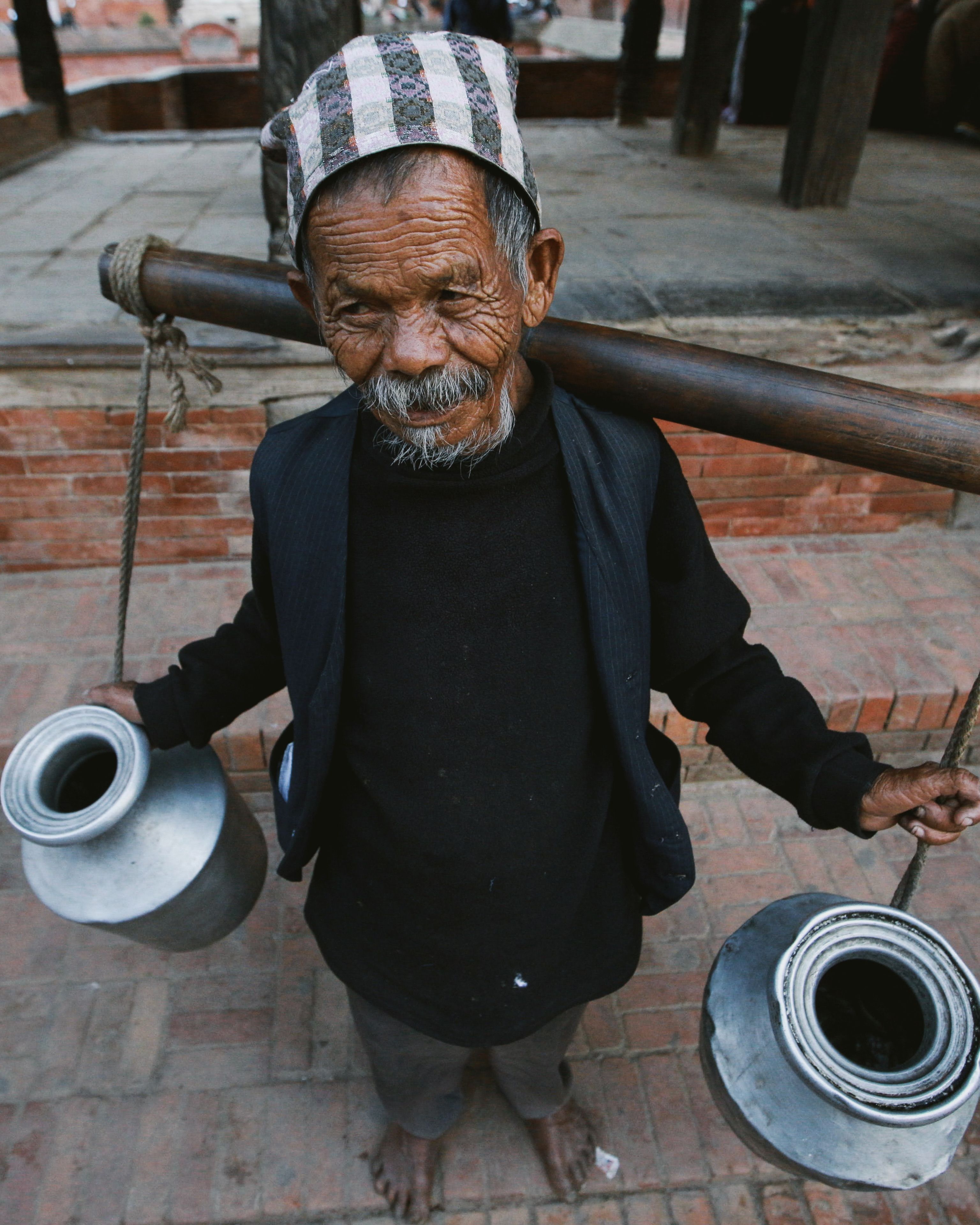 Elderly Man Carrying Two Metal Buckets · Free Stock Photo