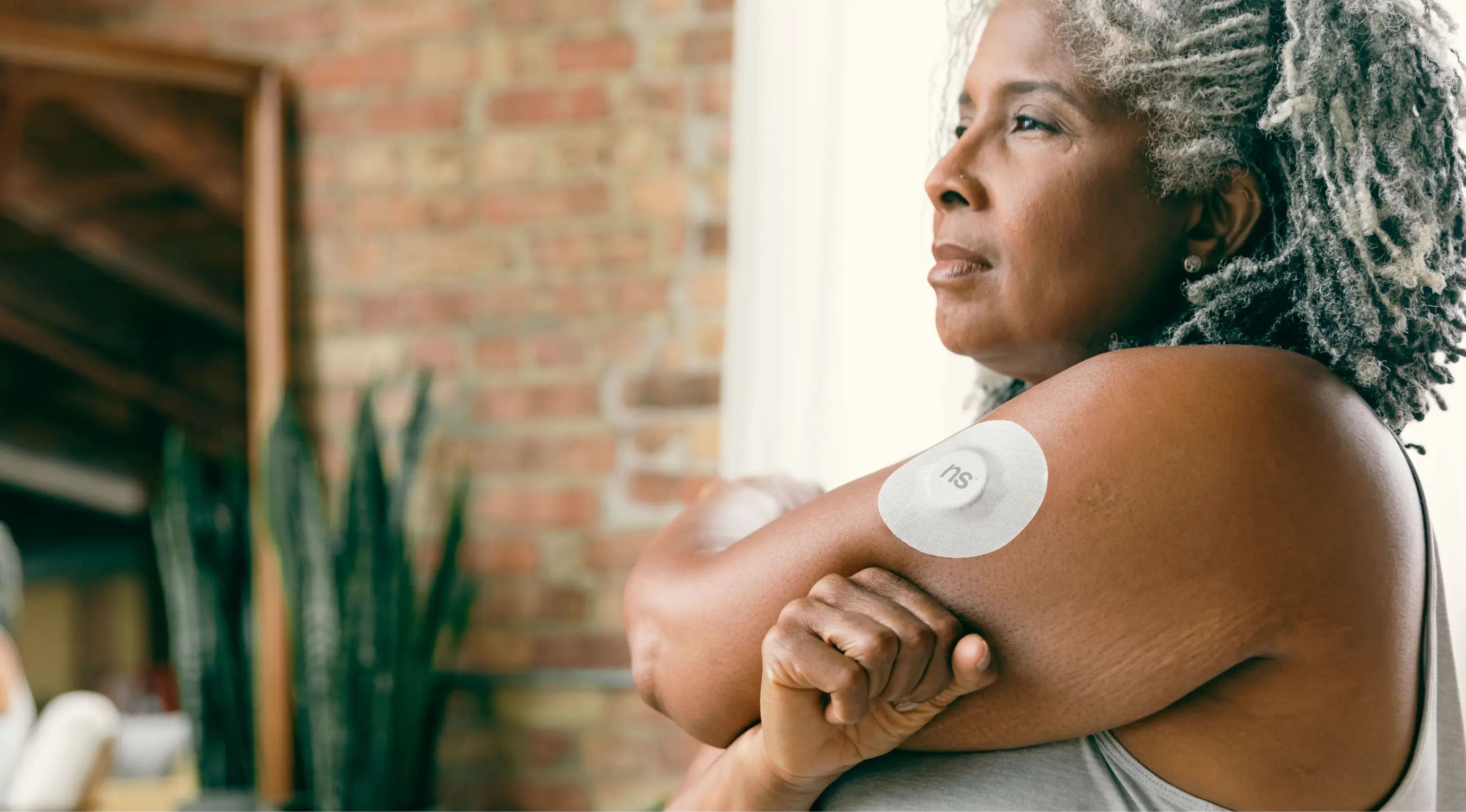 Woman with Diabetes Wearing a CGM Device on Her Arm · Free Stock Photo