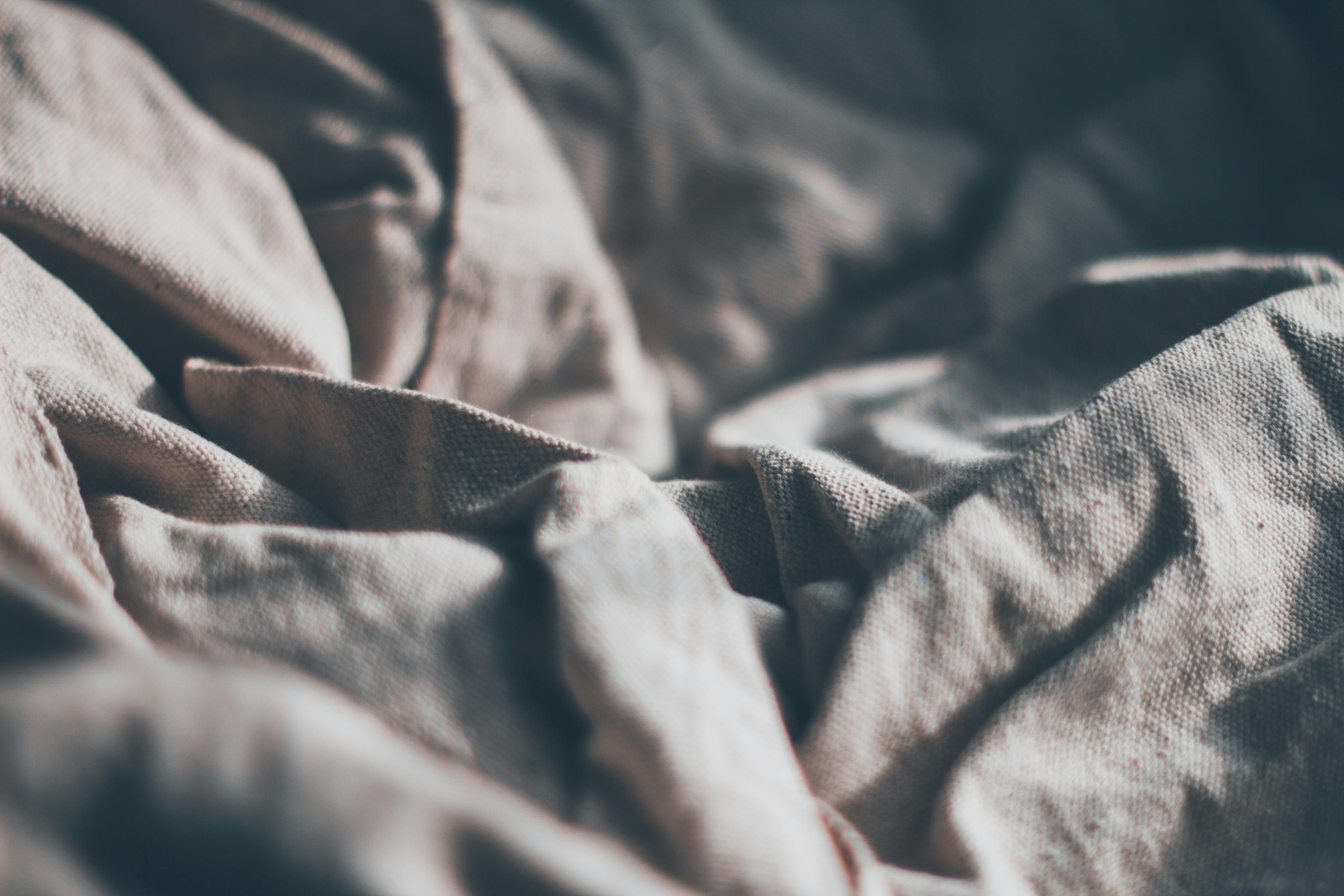 Crumpled fabric on soft bed · Free Stock Photo