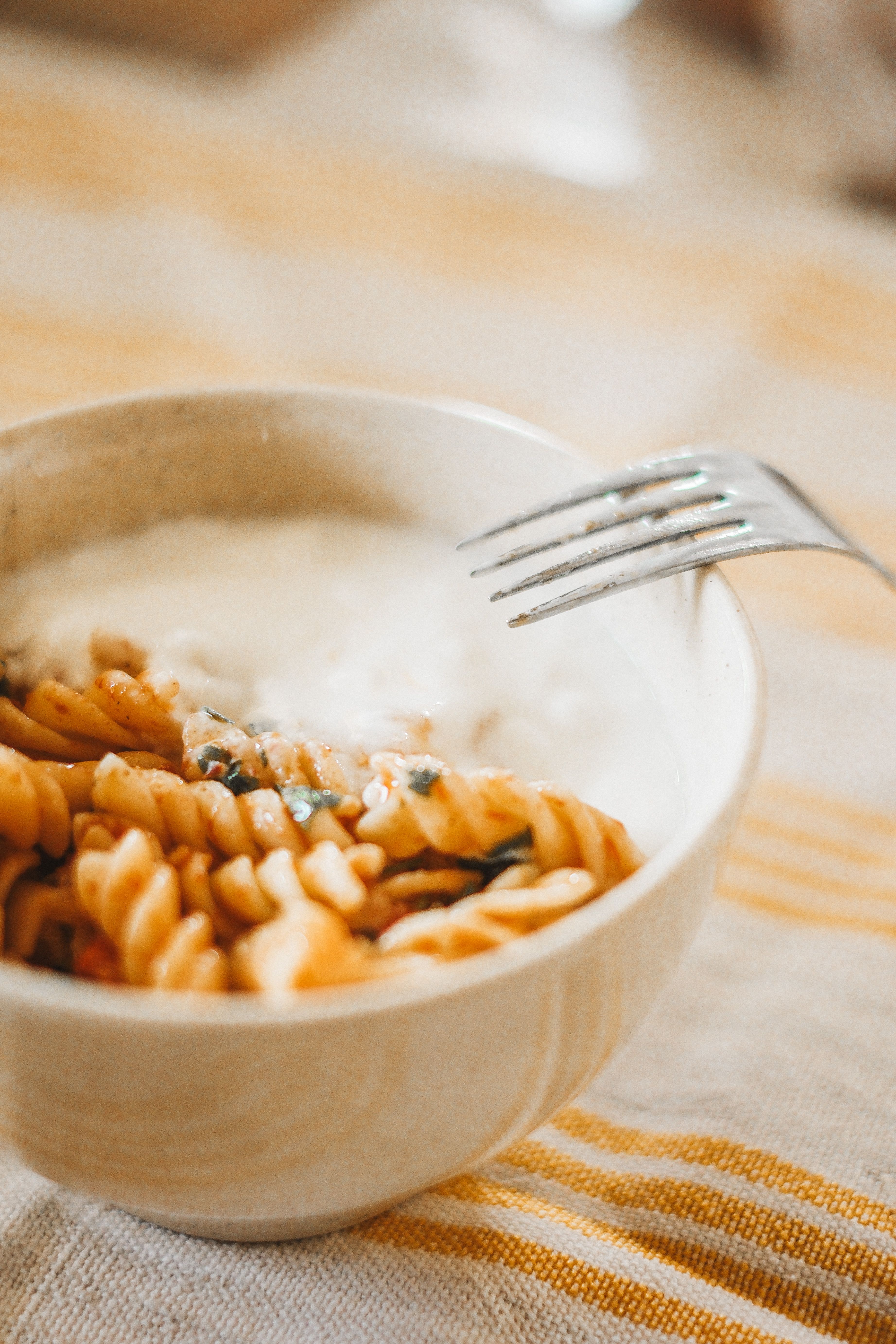 Bowl of Spiral Fusilli Pasta on a Table · Free Stock Photo