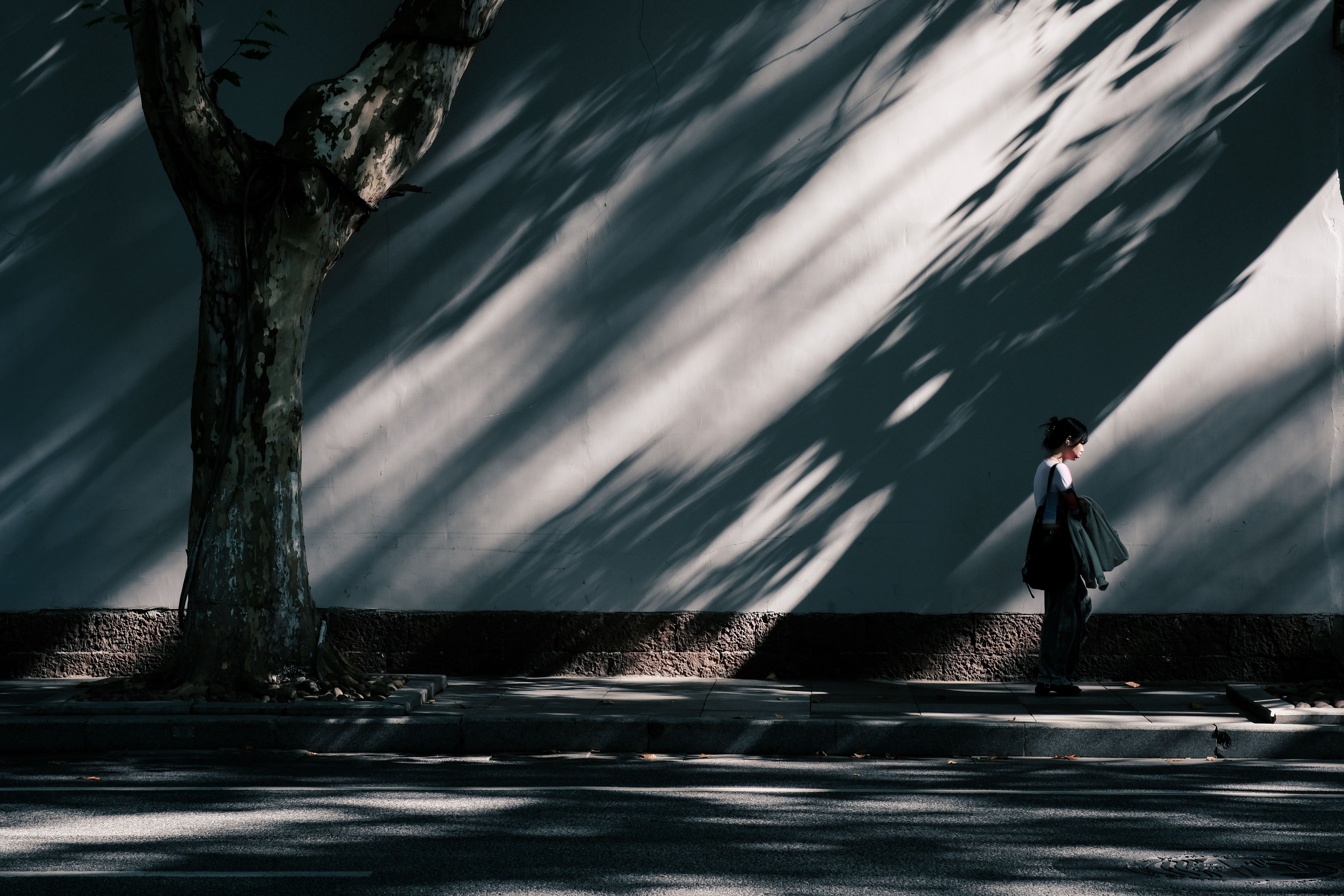 Woman Standing near Shadows on Wall · Free Stock Photo