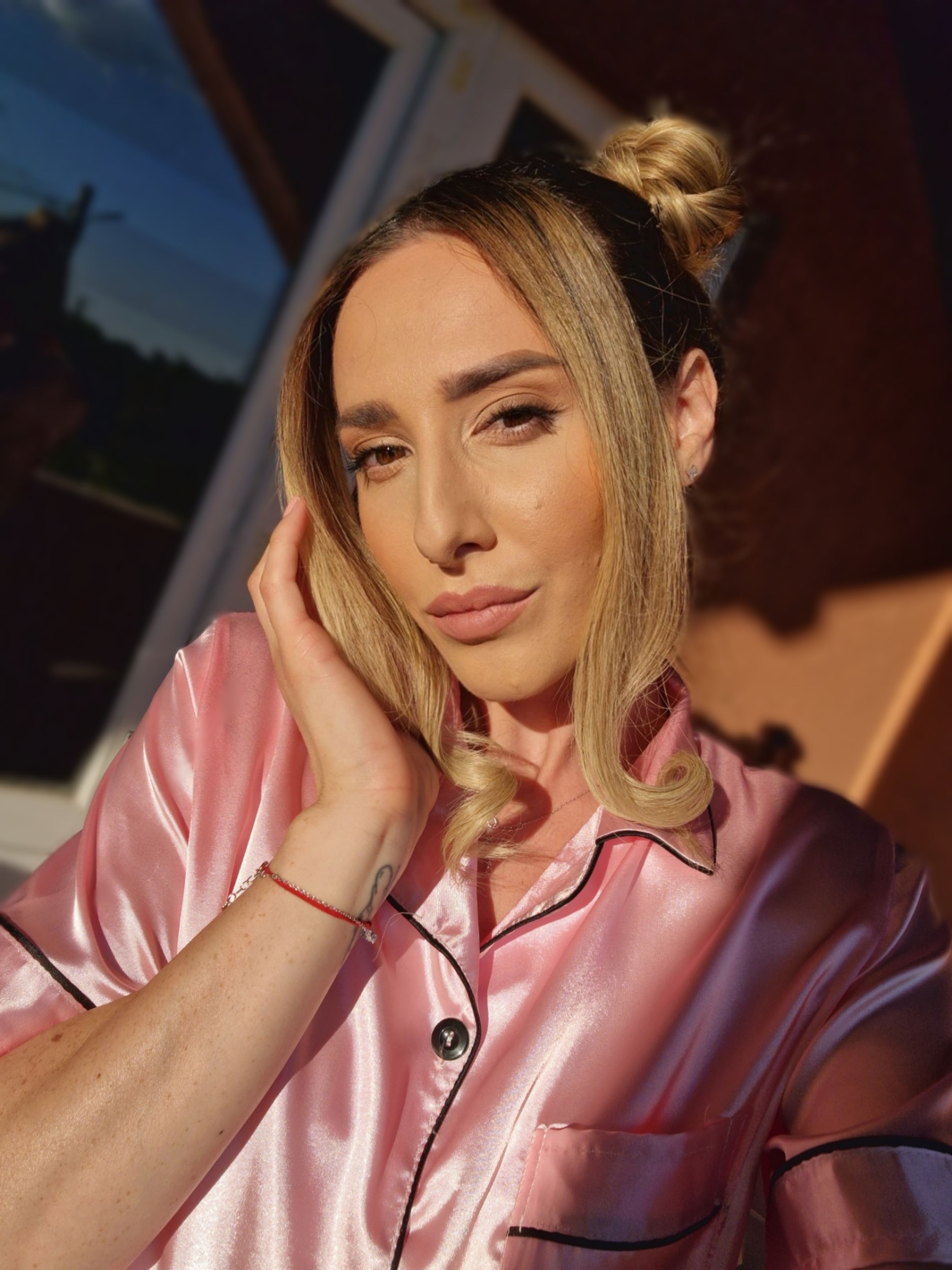 Young Woman in a Silk Shirt Taking a Selfie · Free Stock Photo