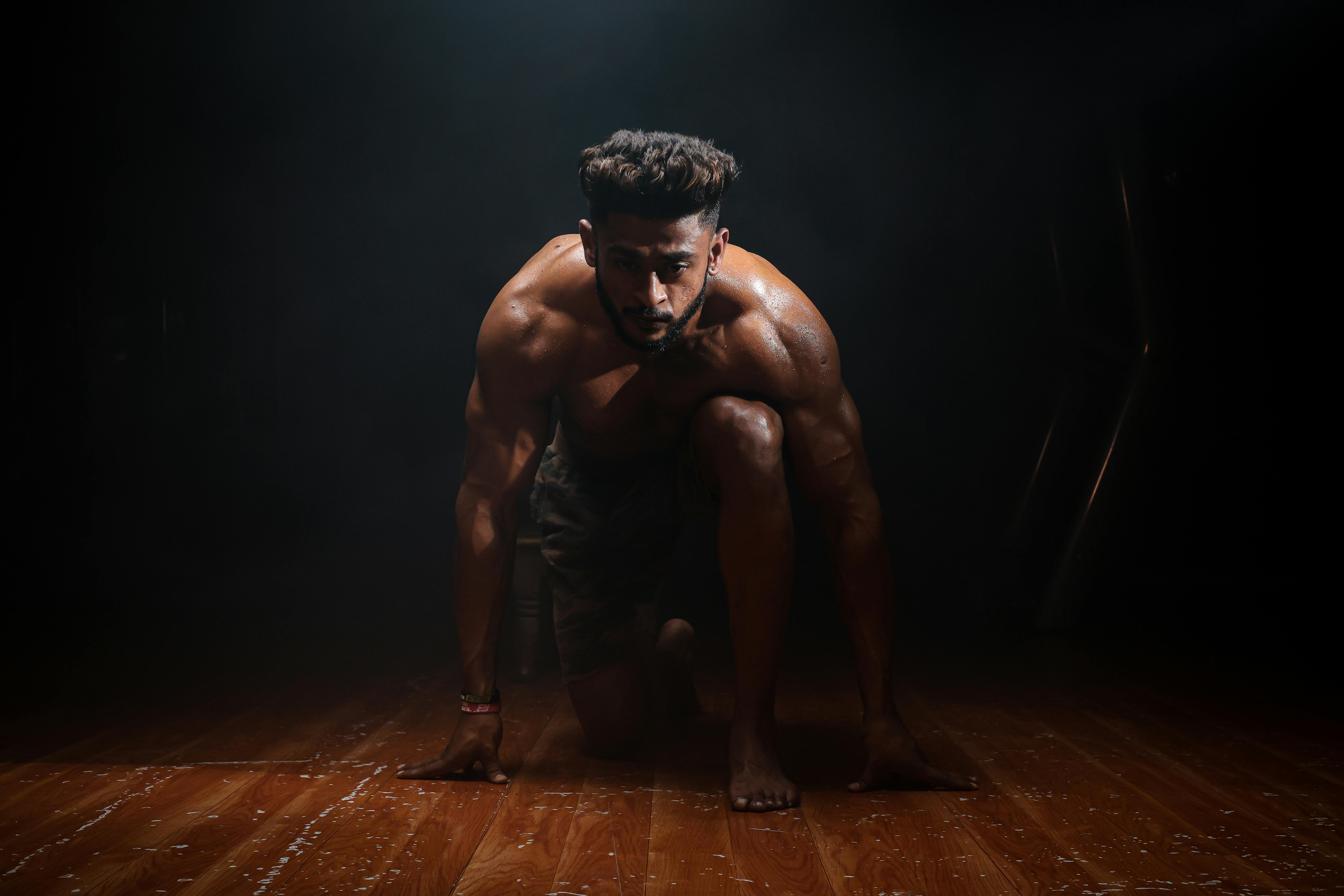 Kneeling Muscular Man · Free Stock Photo
