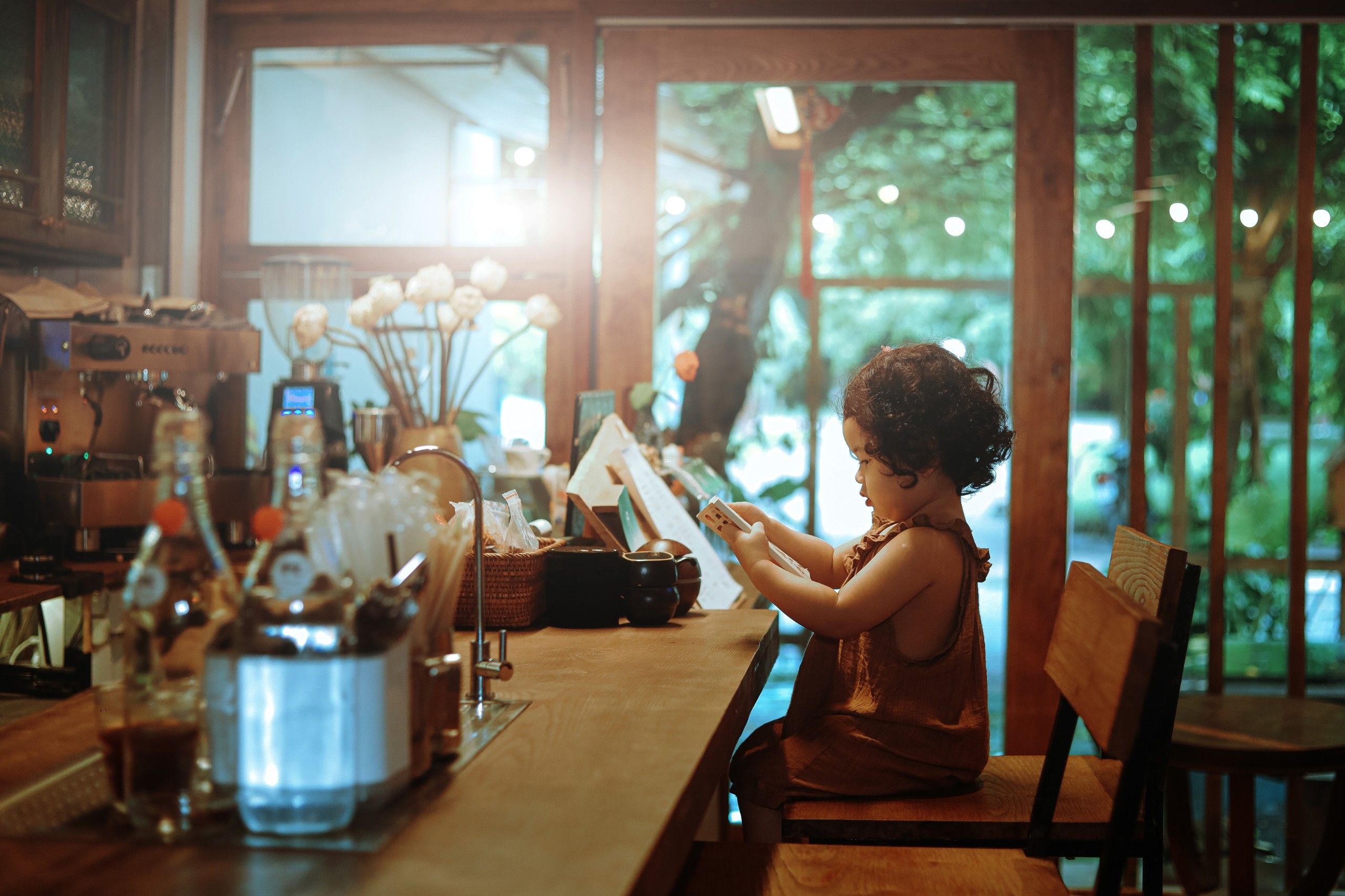 Child Reading in a Cafe · Free Stock Photo