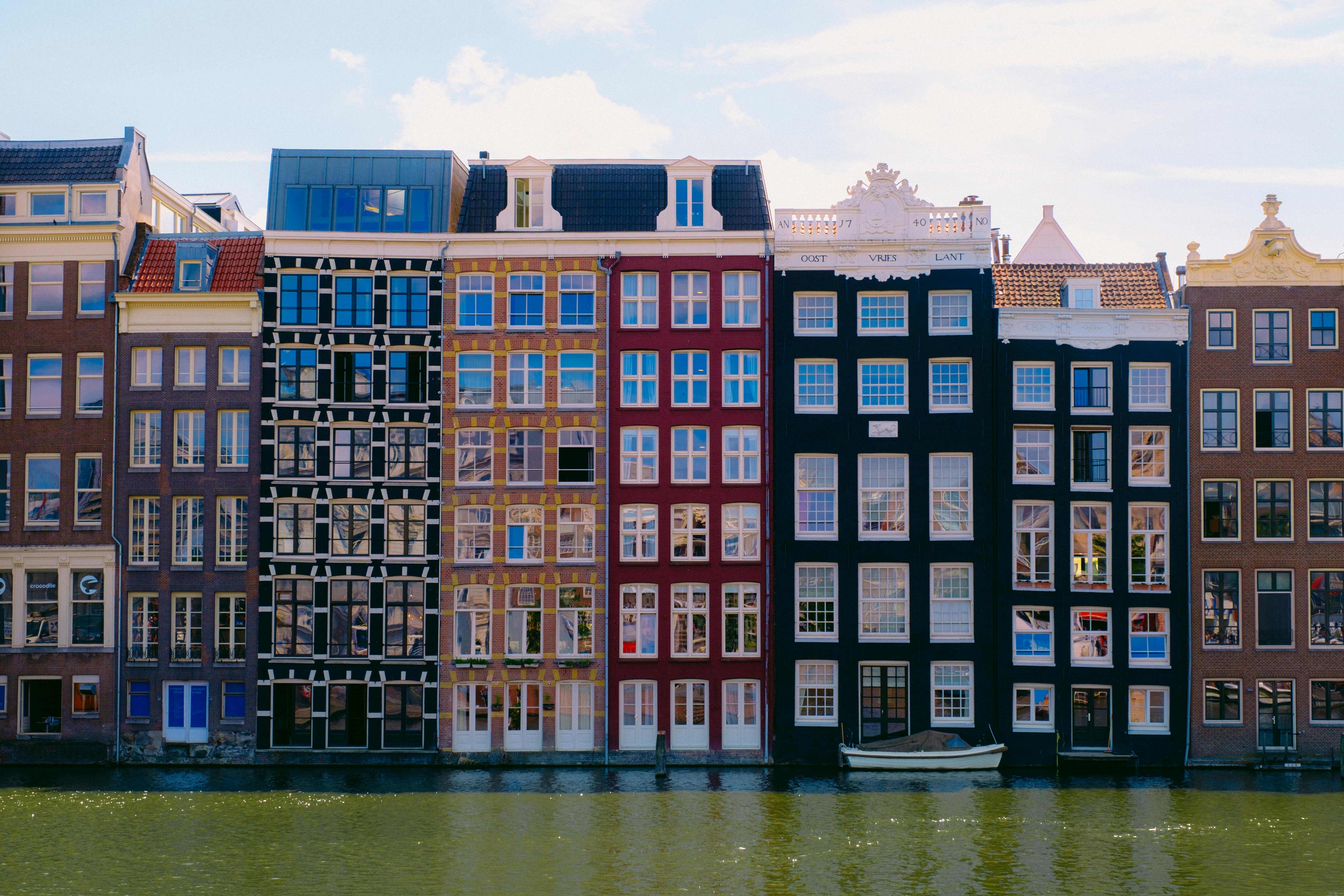 Colorful Facade of Amsterdam Waterfront Houses · Free Stock Photo