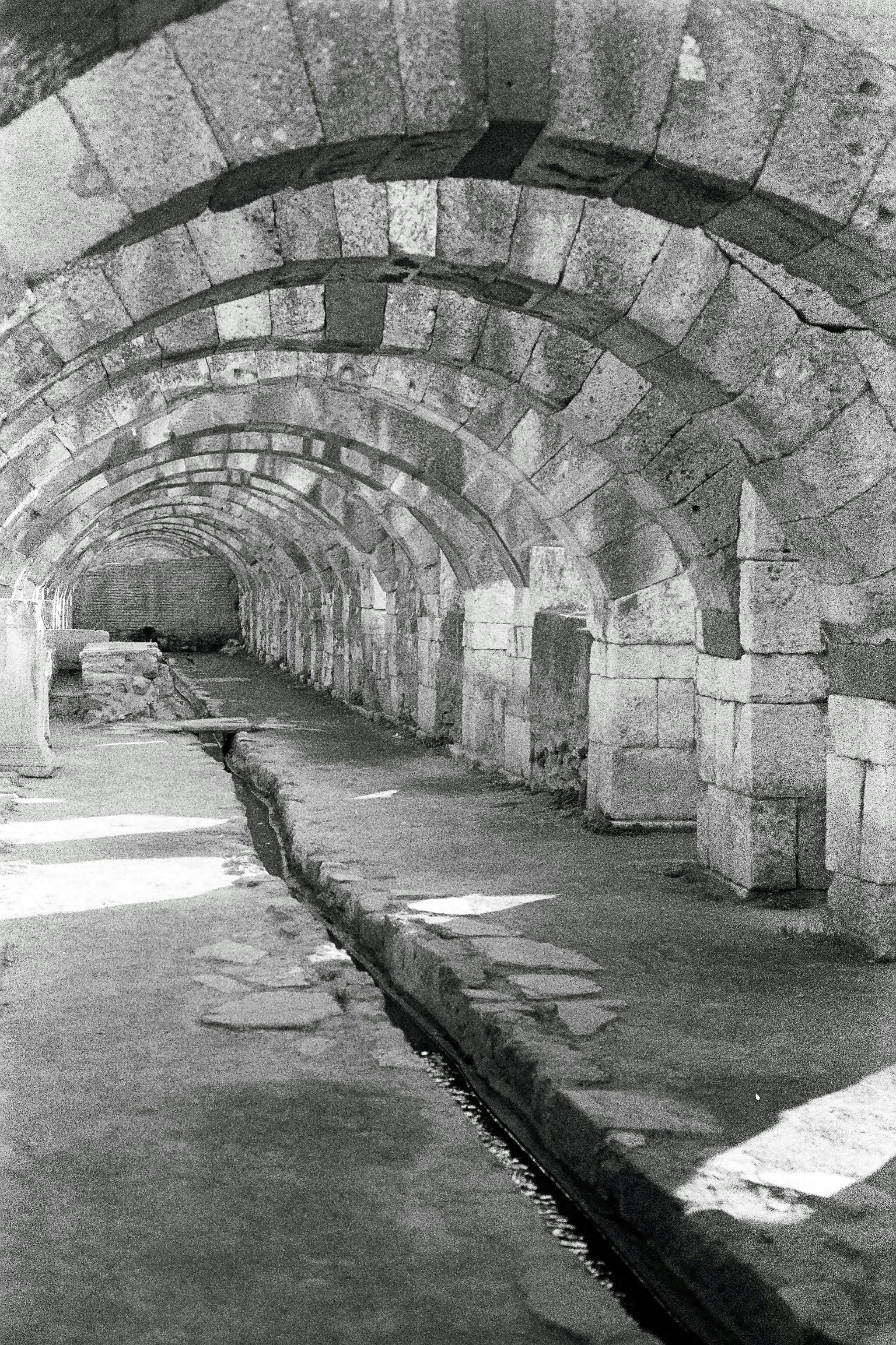 Stone Arches in Corridor · Free Stock Photo