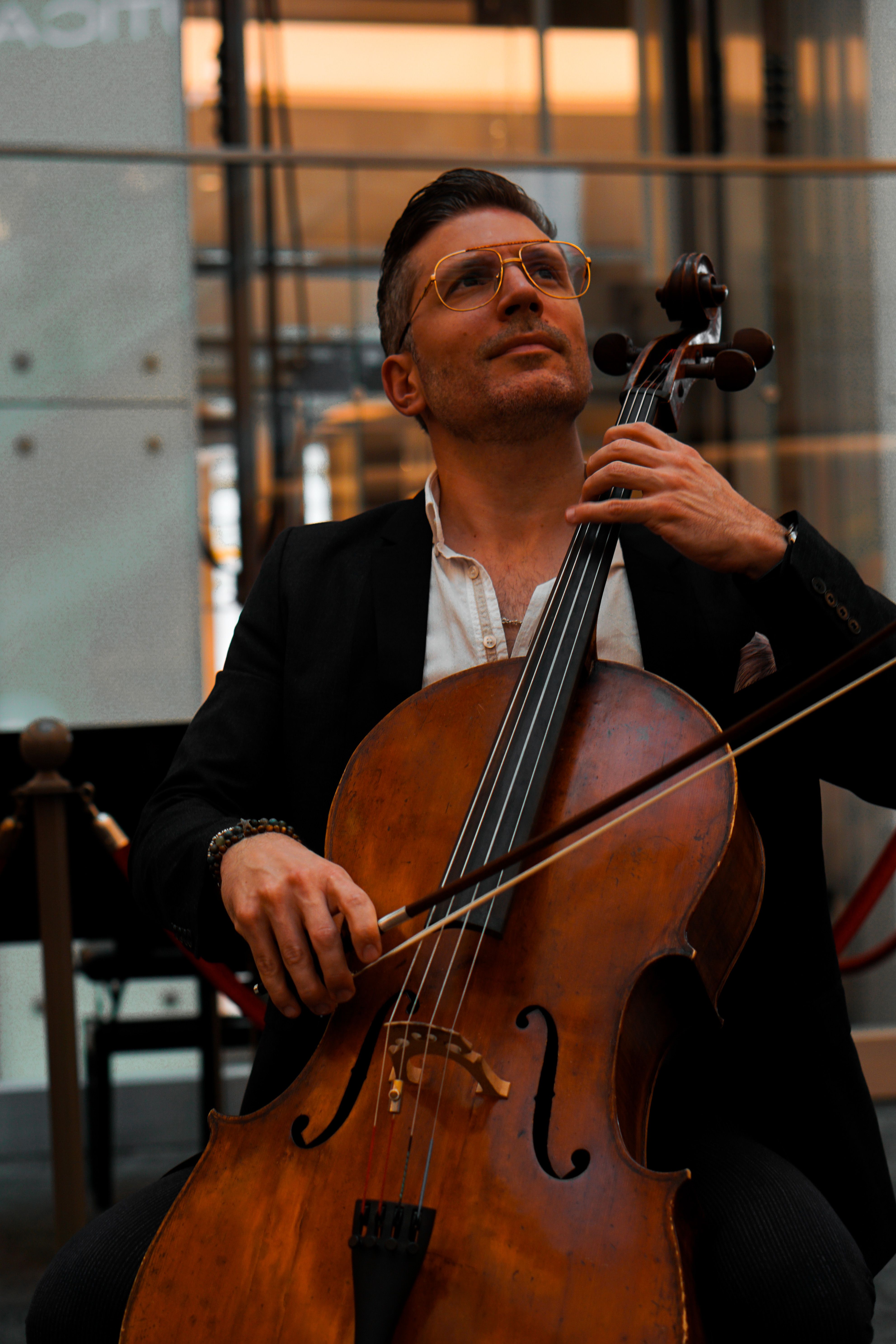 Man in Suit Playing on Cello · Free Stock Photo