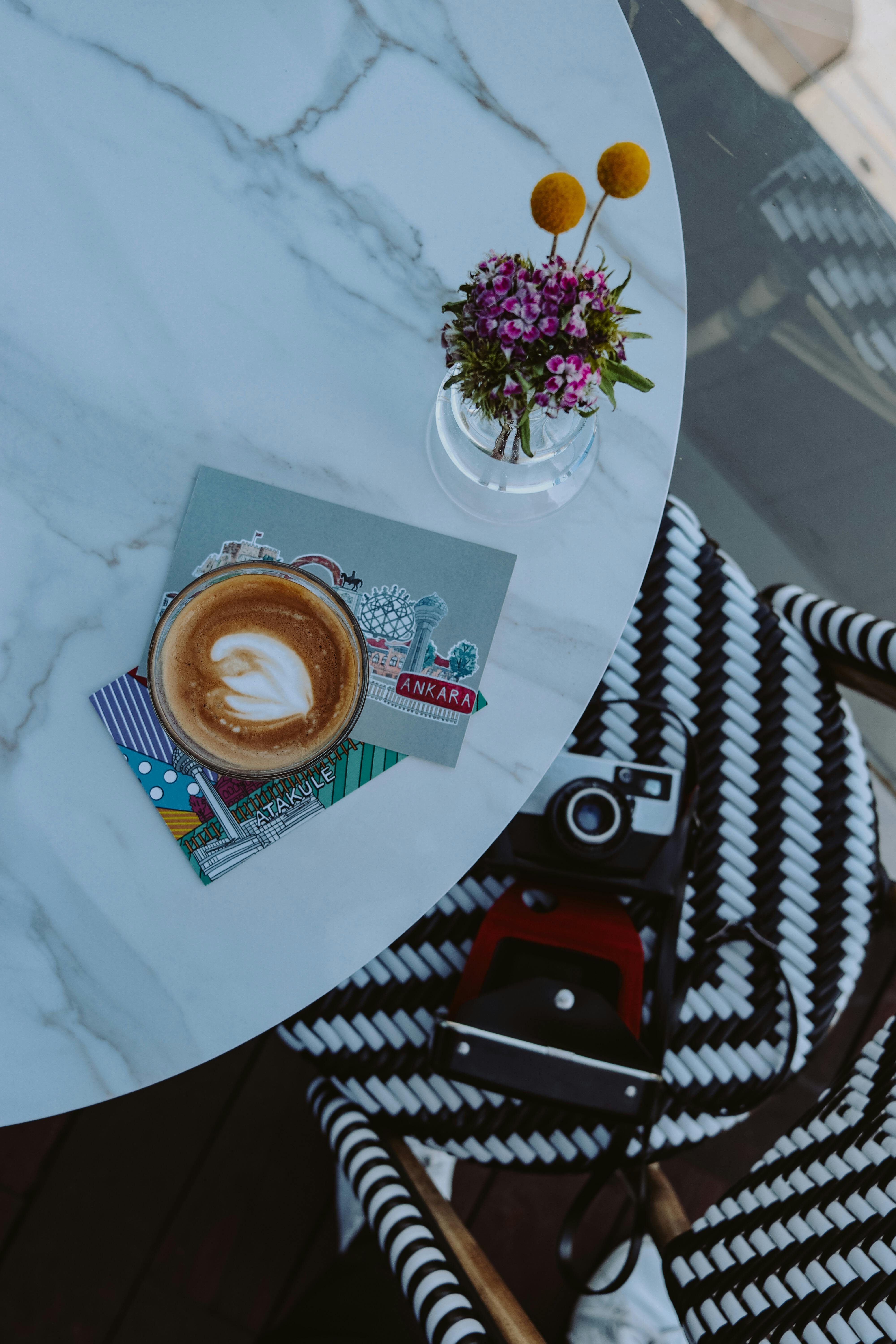 Coffee in Cup and Retro Camera on Cafe Table · Free Stock Photo