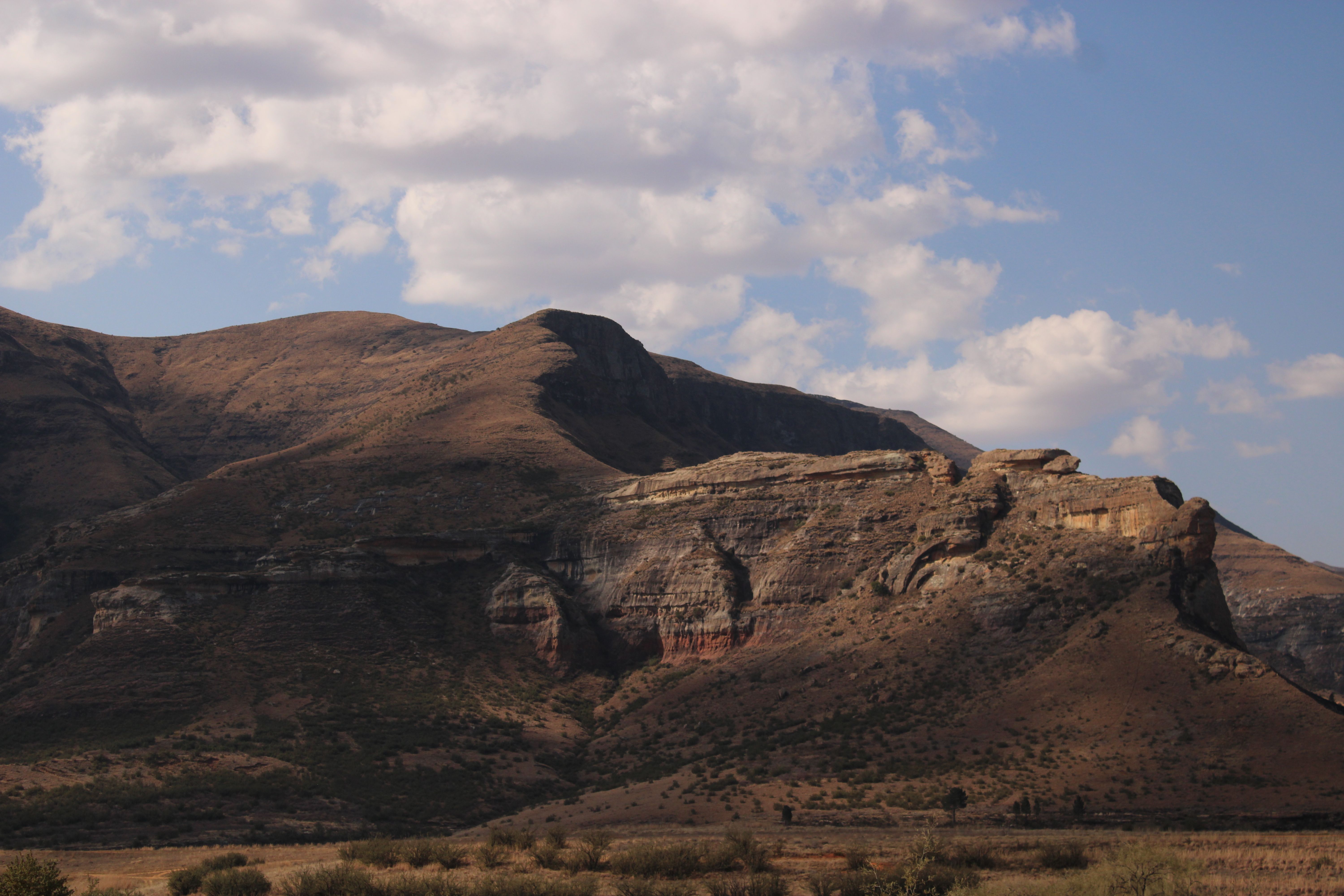 Field at the Bottom of a Sandstone Hill · Free Stock Photo