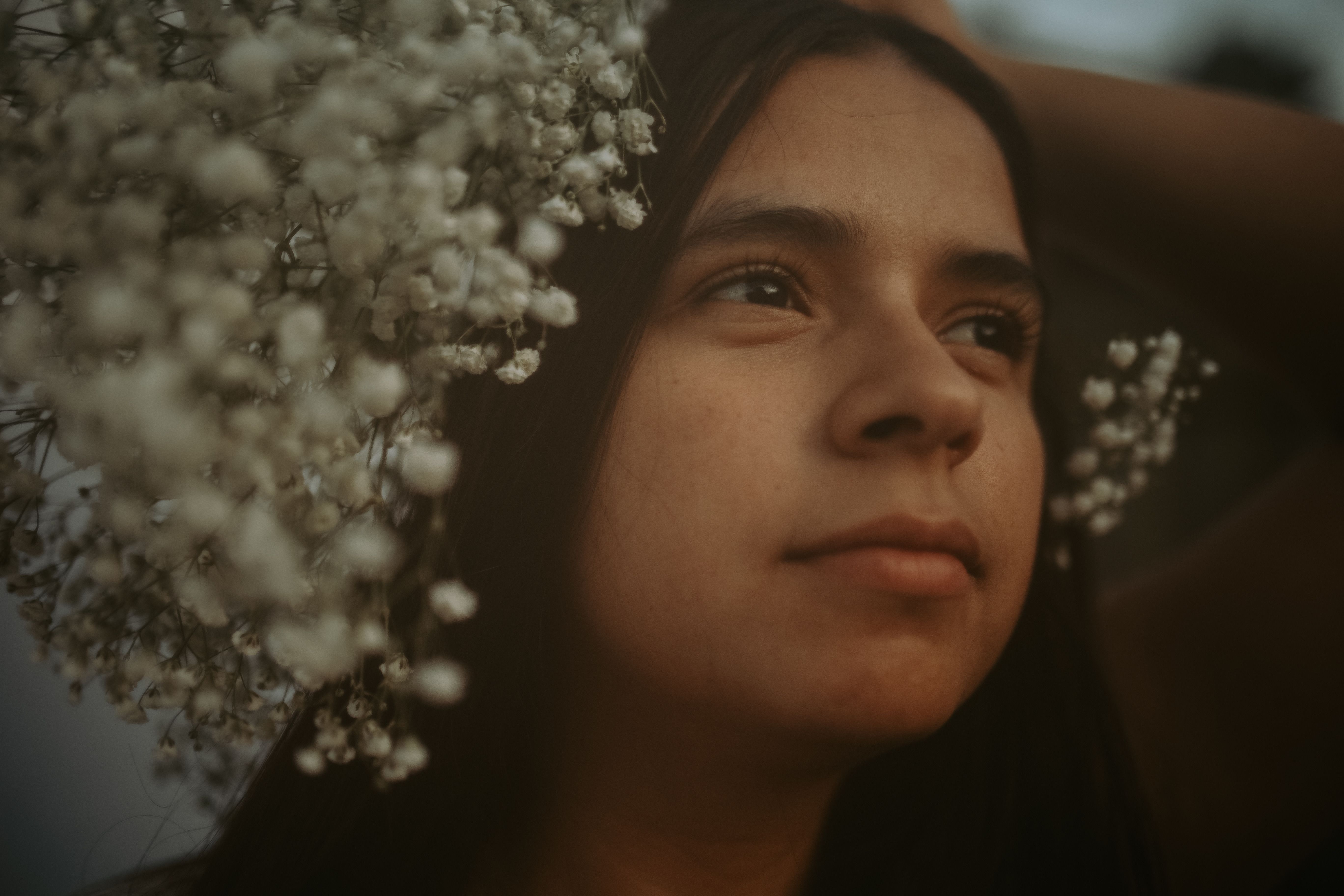 Close-up Photo of Woman's Face Behind White Flowers · Free Stock Photo