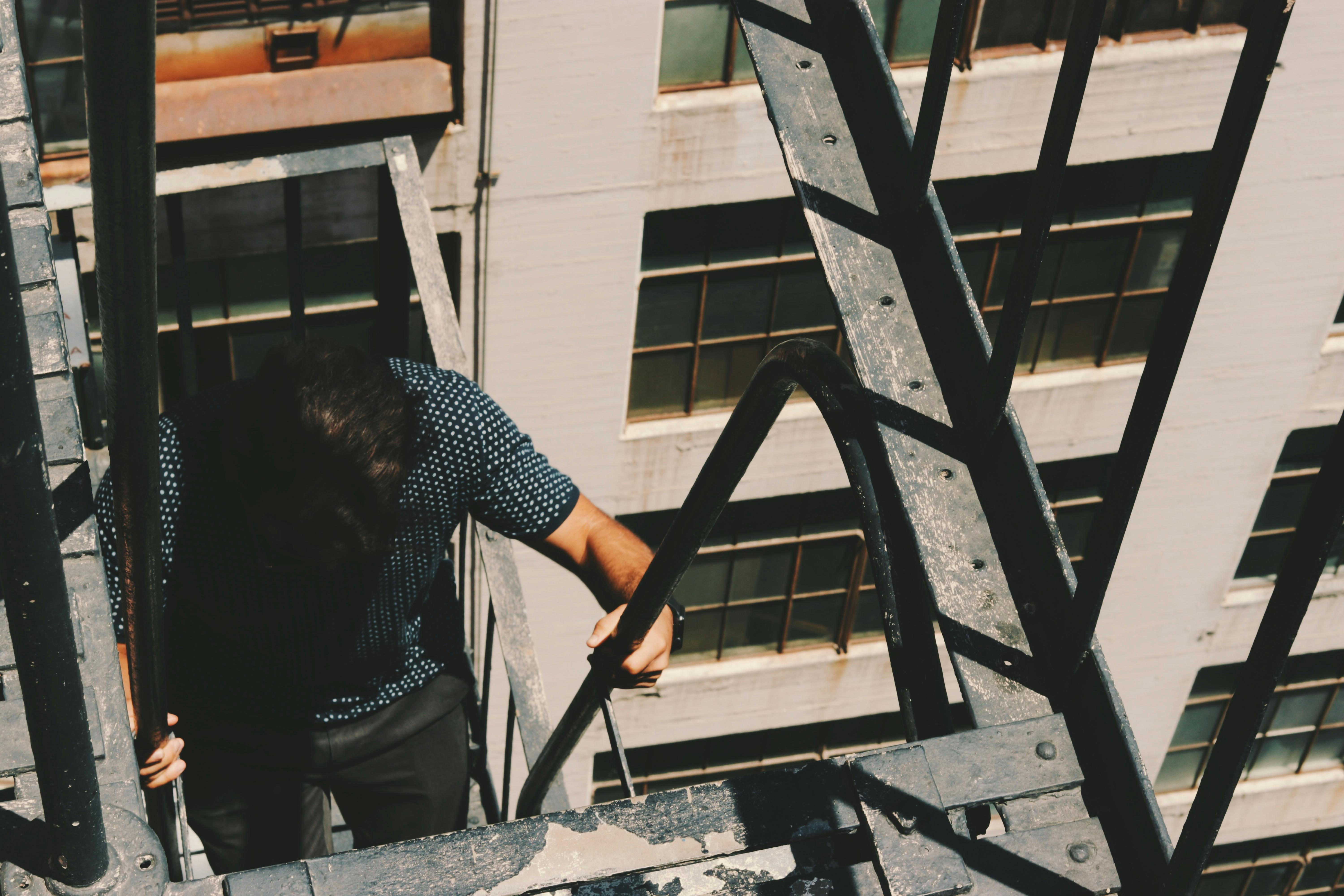 Man Climbing Side Building Stairs · Free Stock Photo