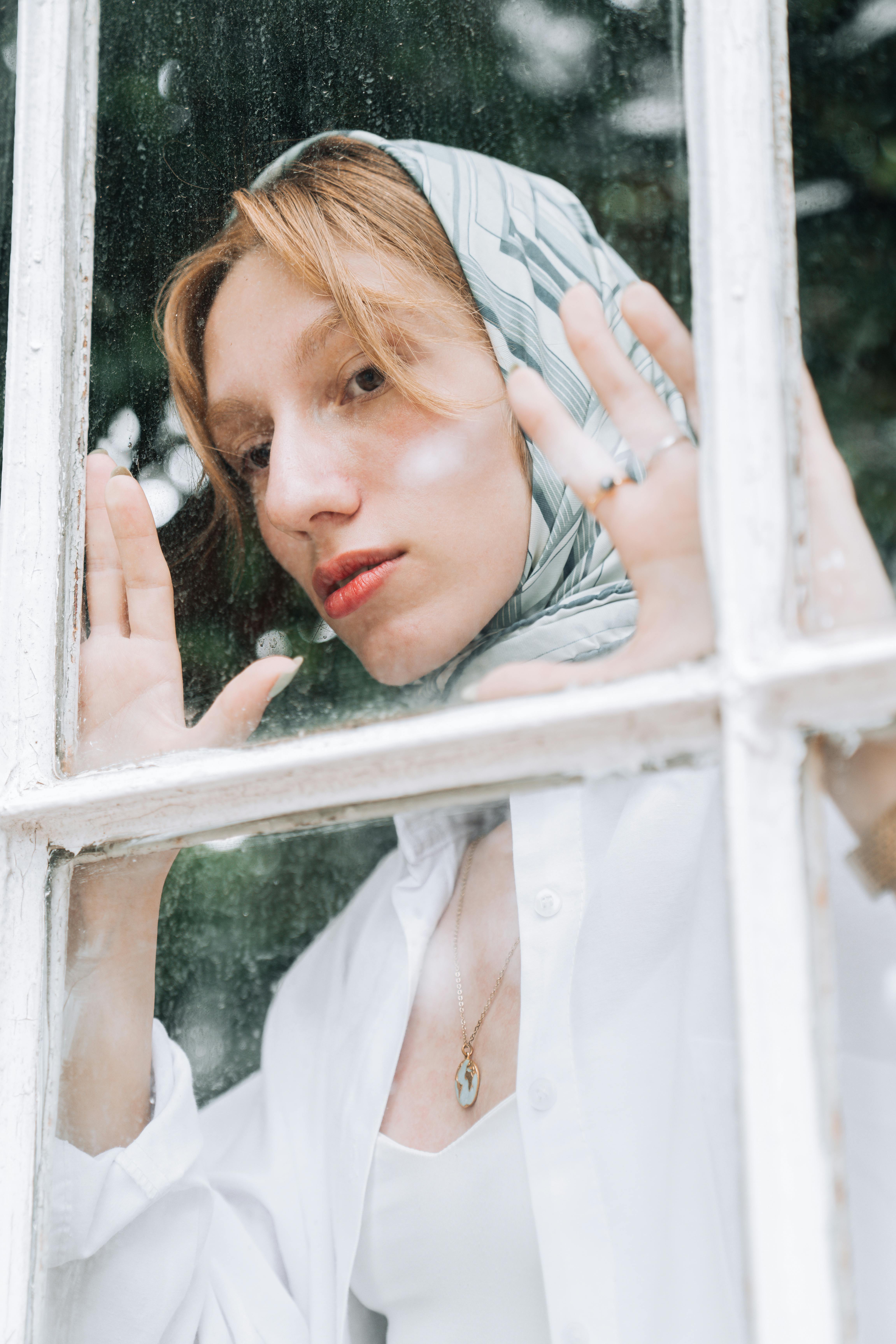 Model in Blue Headscarf and White Blouse Standing in the Window · Free ...