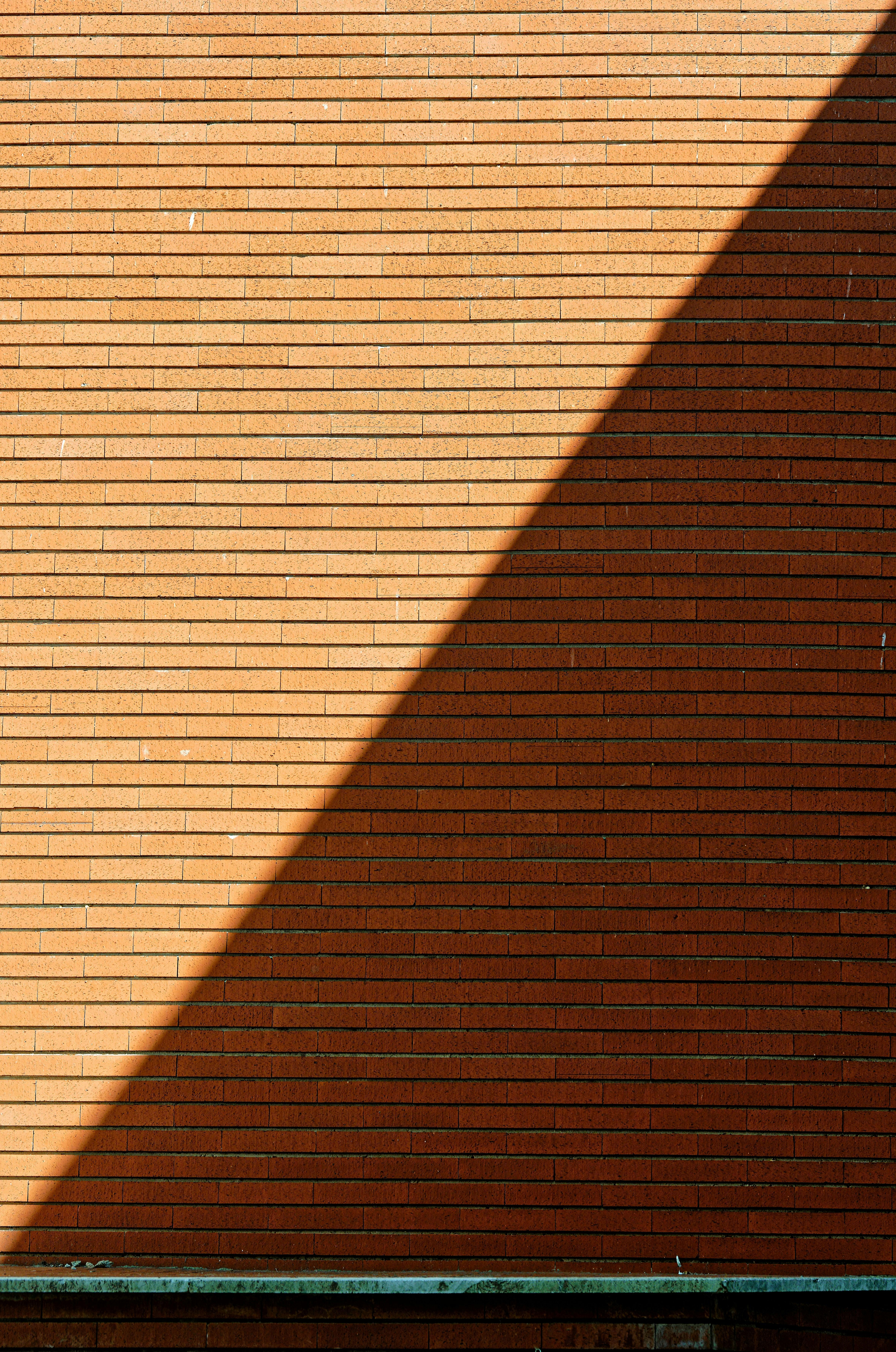 Triangle of Shadow on Sunlit Wall · Free Stock Photo