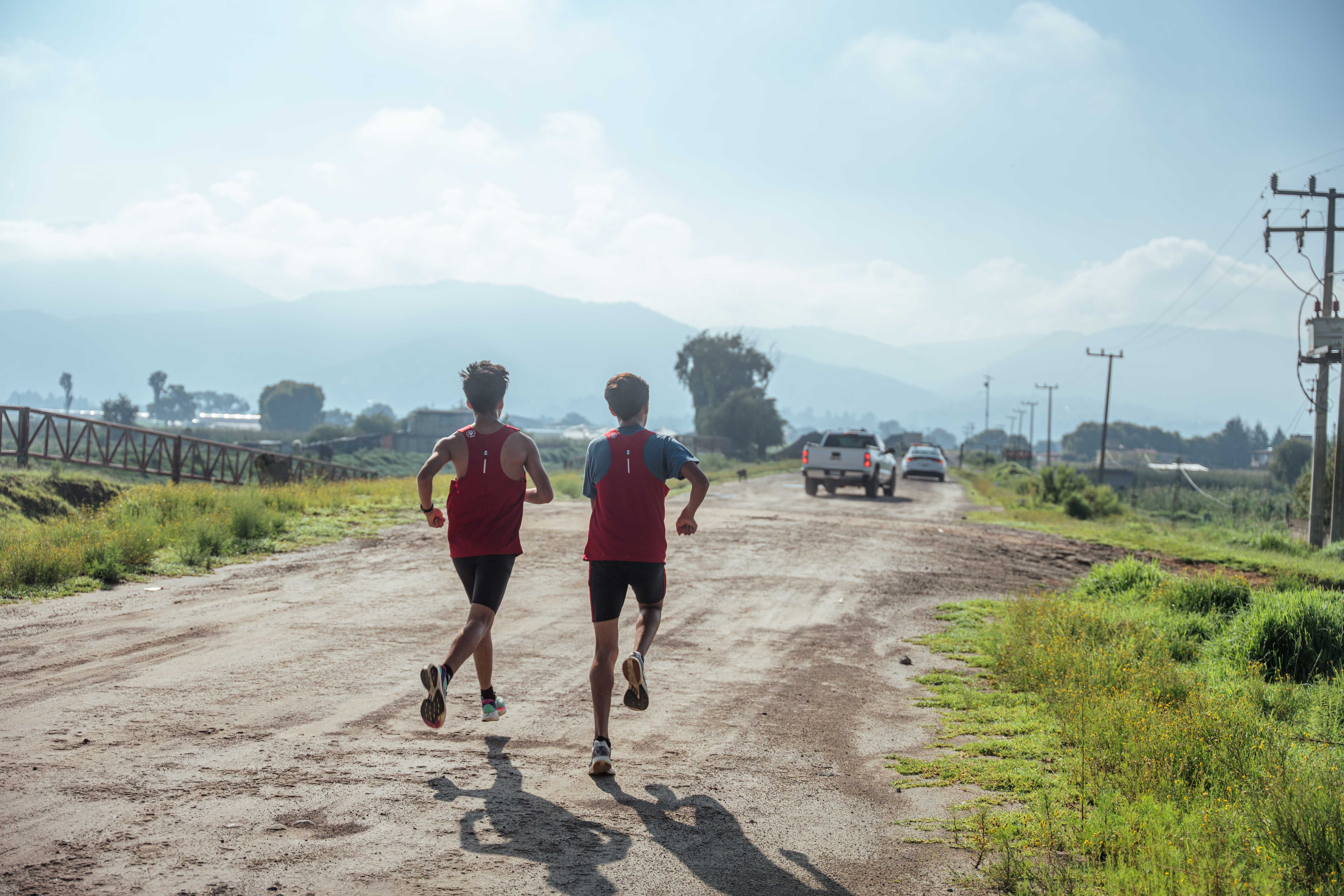 Boys Running Down a Rural Road · Free Stock Photo