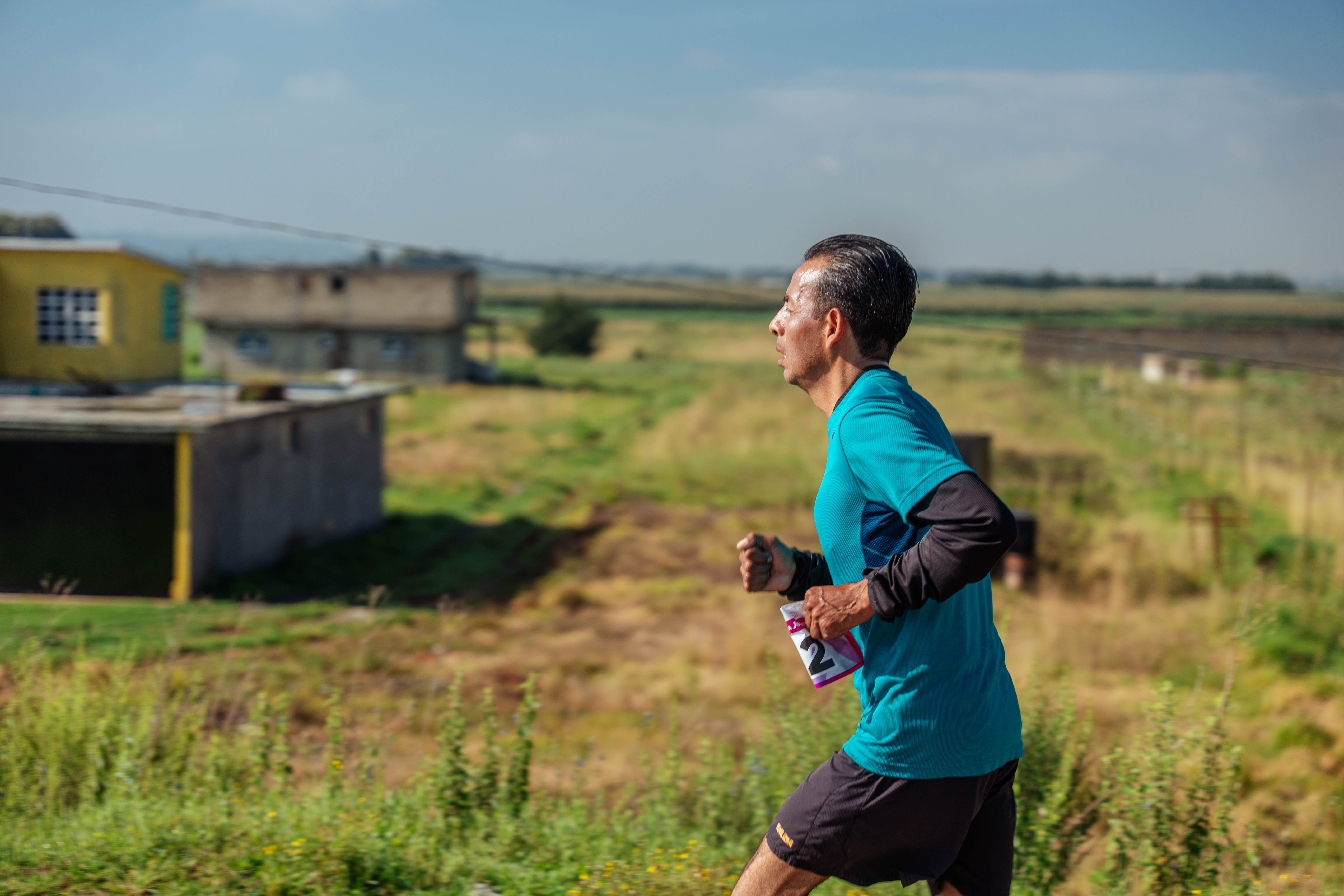 Man Running in Race in Village · Free Stock Photo