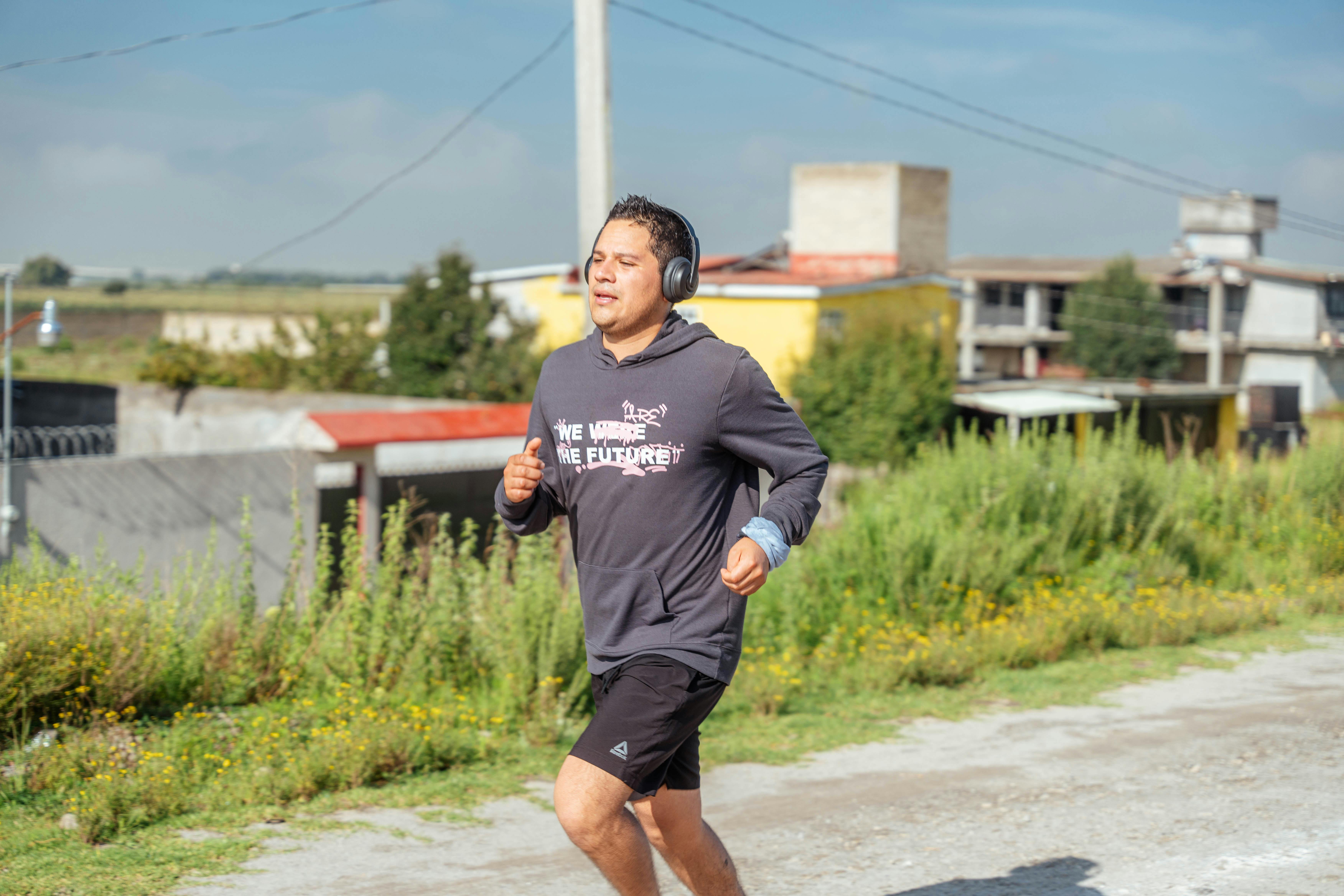 Man Running a Marathon in Headphones · Free Stock Photo