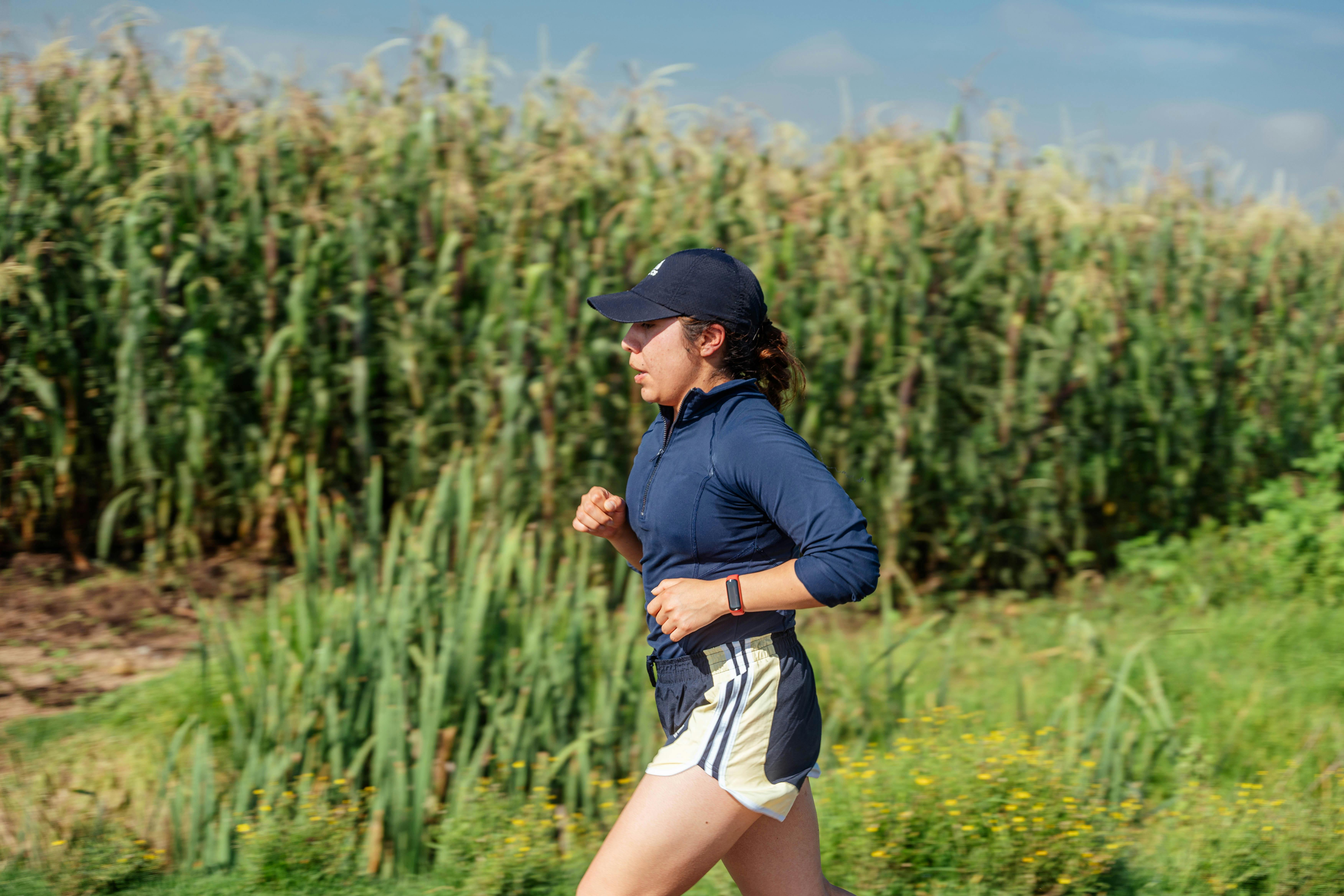 Woman Running near Field · Free Stock Photo