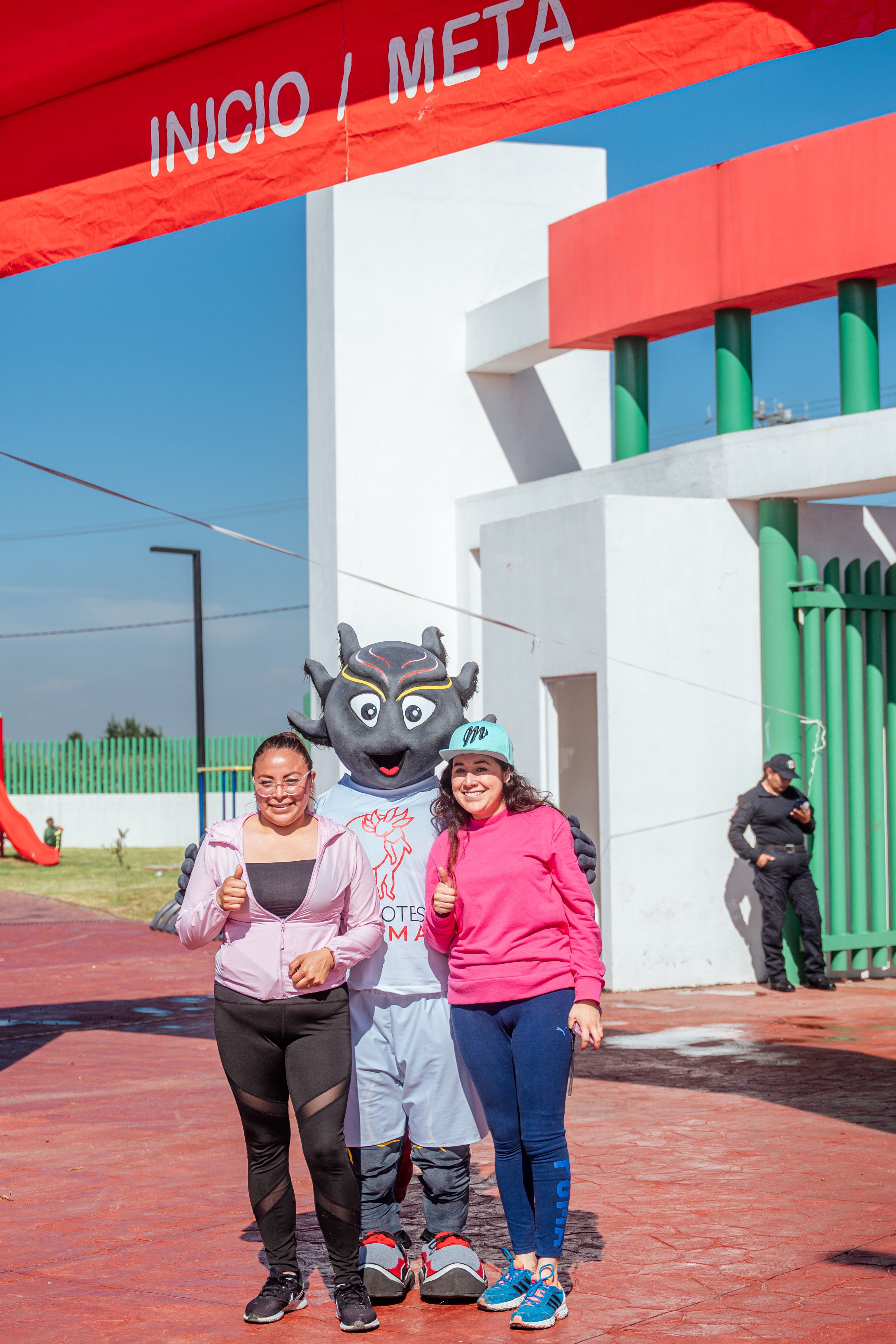 Women Posing with Mascot after Race · Free Stock Photo