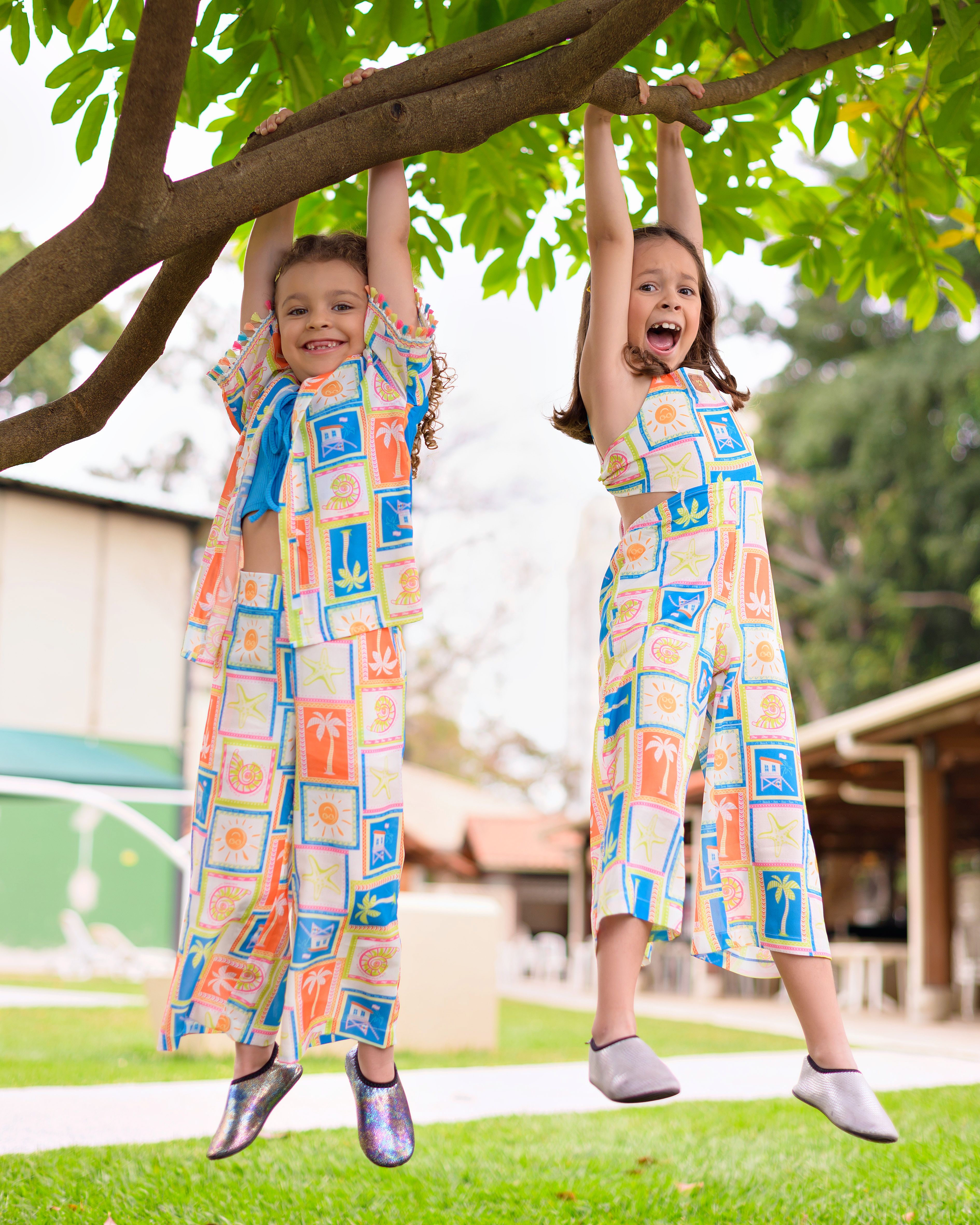 Smiling Girls Hanging on Tree Branch · Free Stock Photo