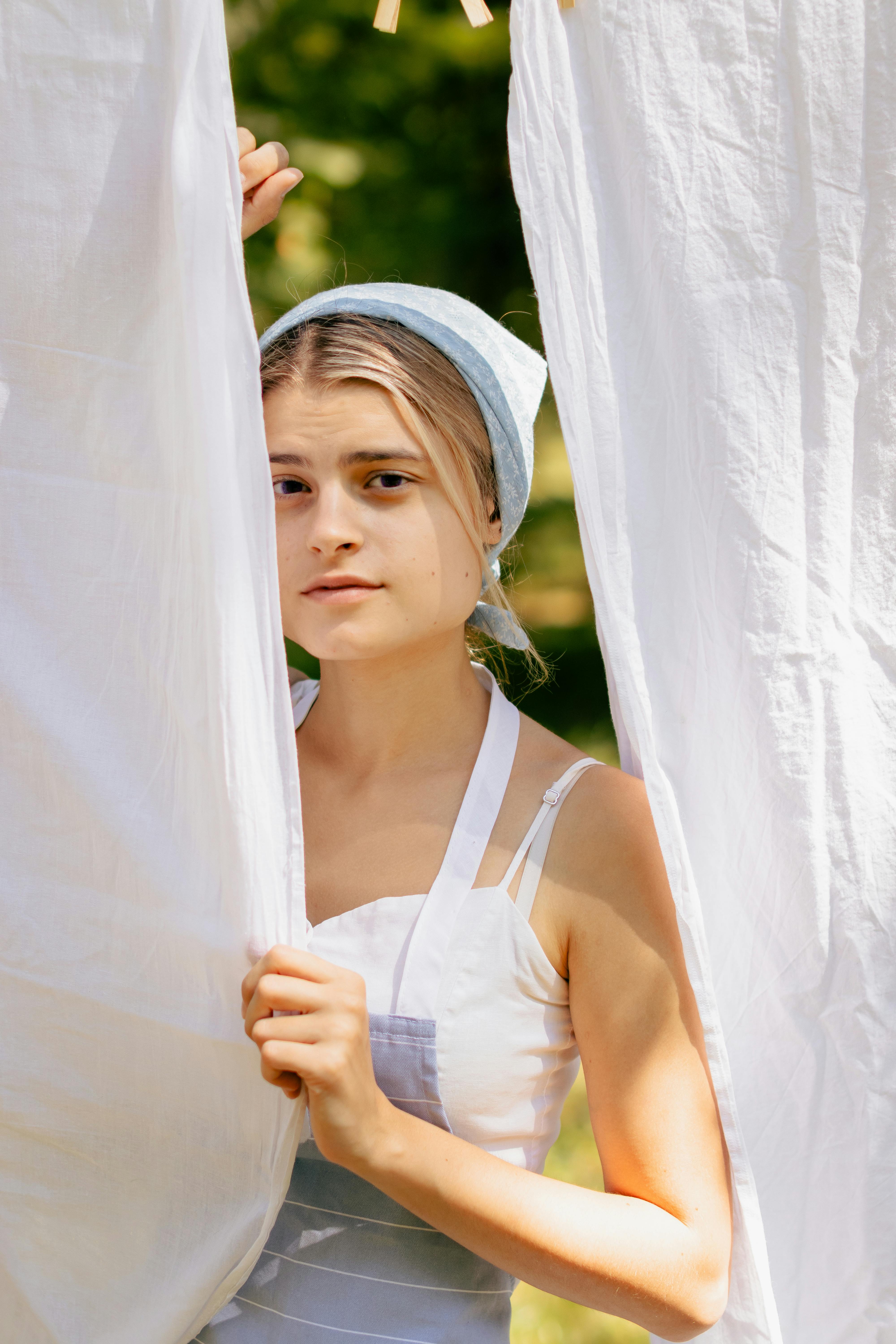 Woman in Apron Hanging Laundry in Yard · Free Stock Photo