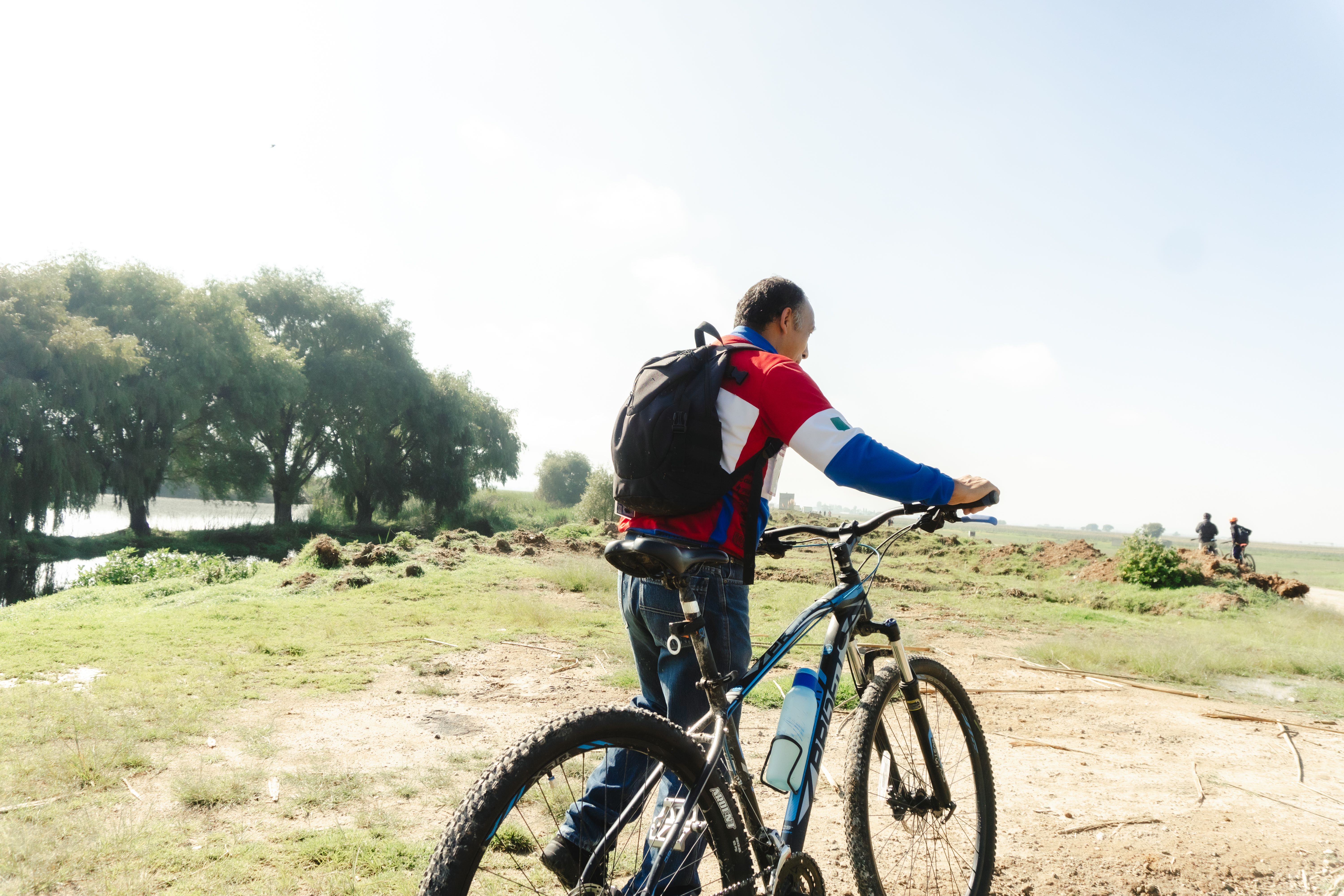 Man Carrying Black Backpack While Riding a Bicycle · Free Stock Photo