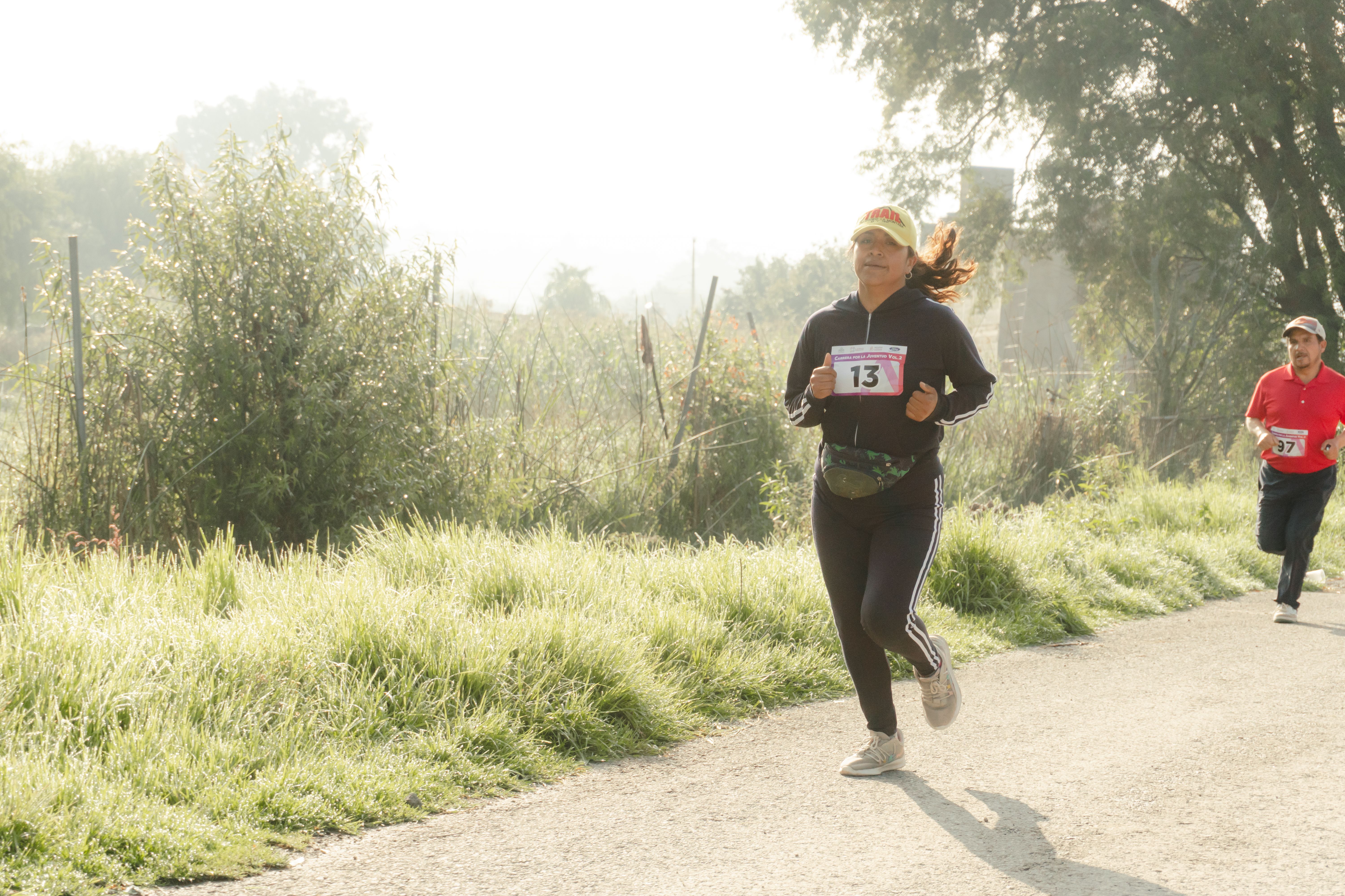 Woman Running in Race on Road · Free Stock Photo