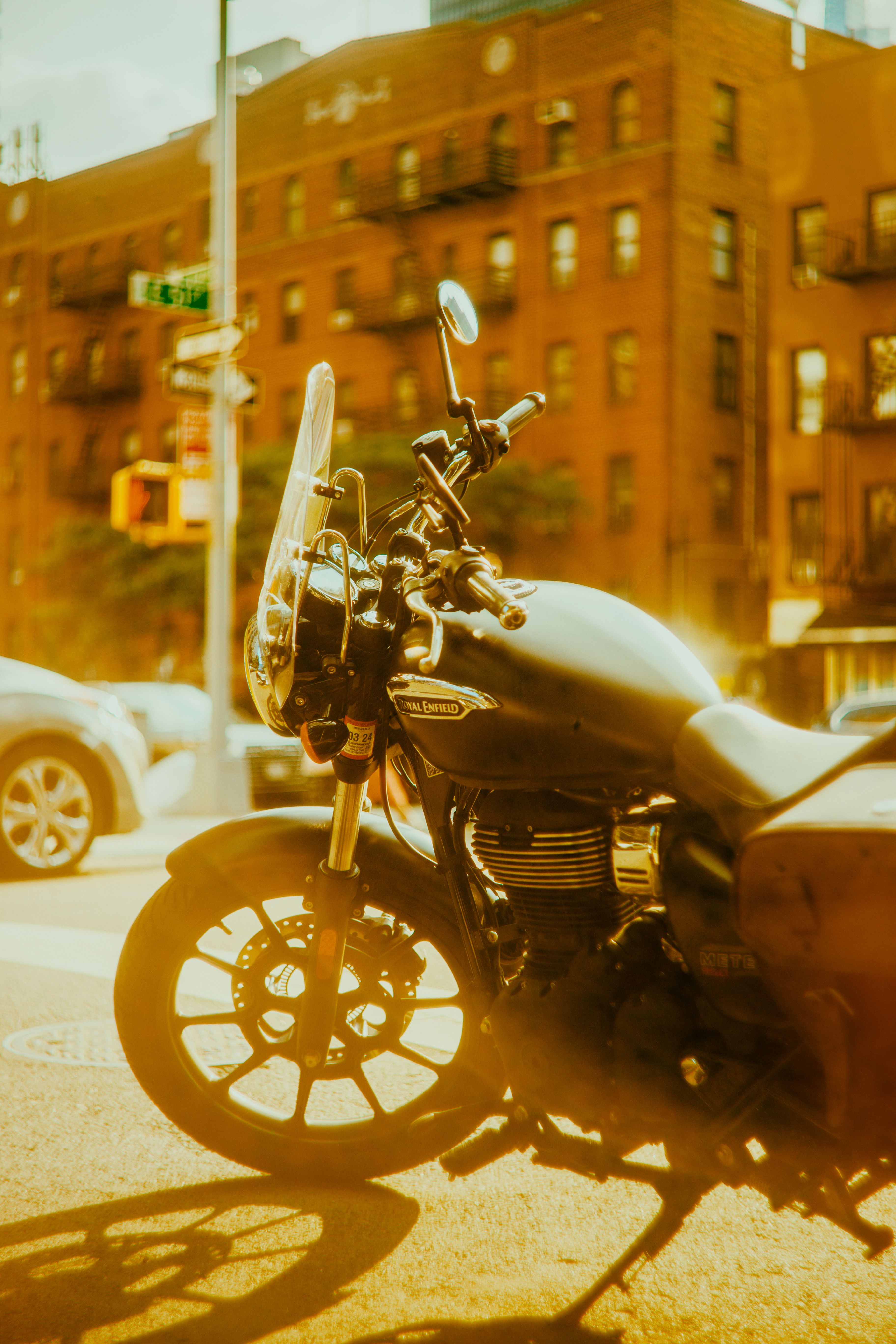 A person riding a motorcycle on a sidewalk in front of tall buildings ...