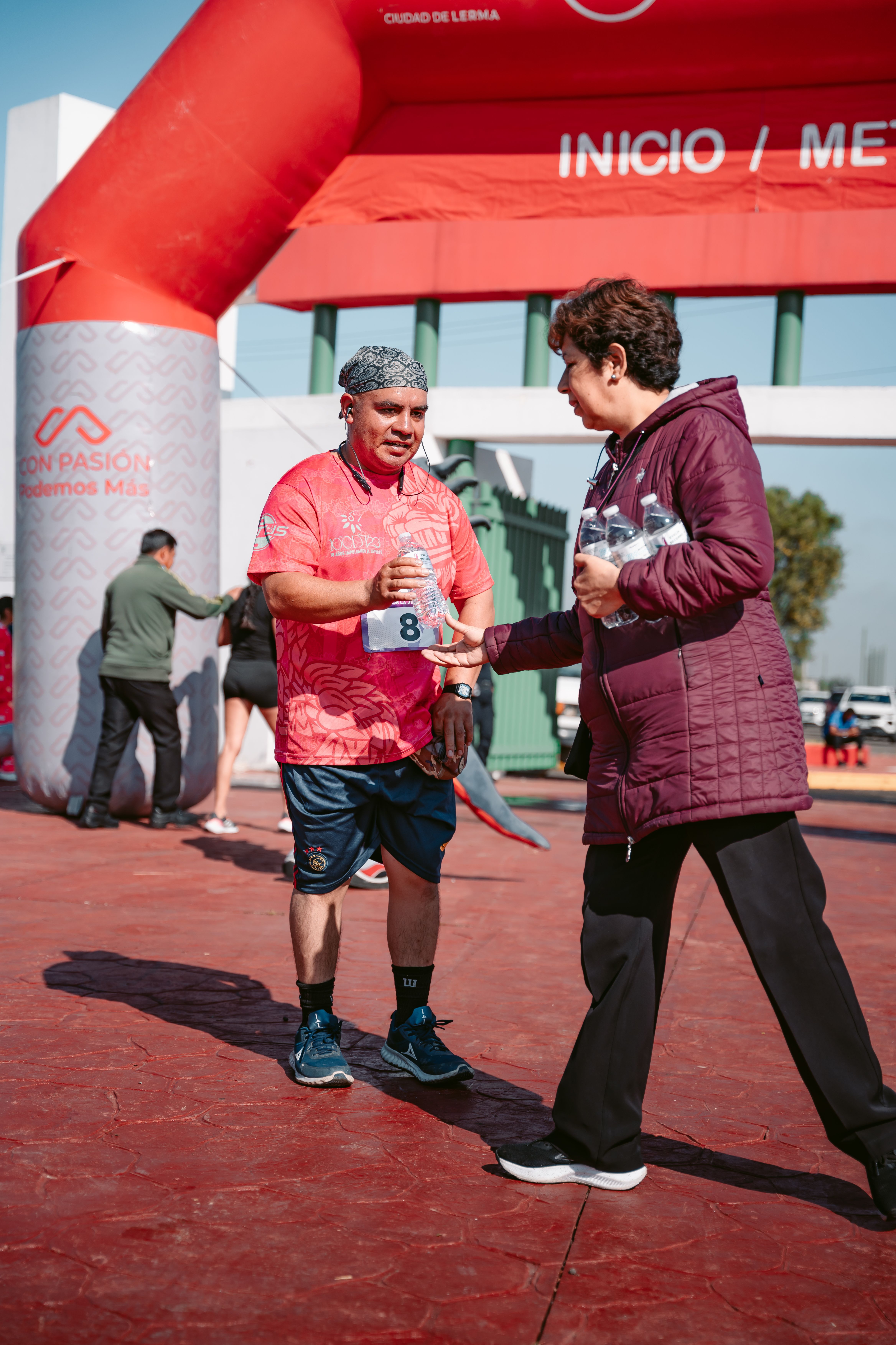 Woman Giving Water to Man after Race · Free Stock Photo