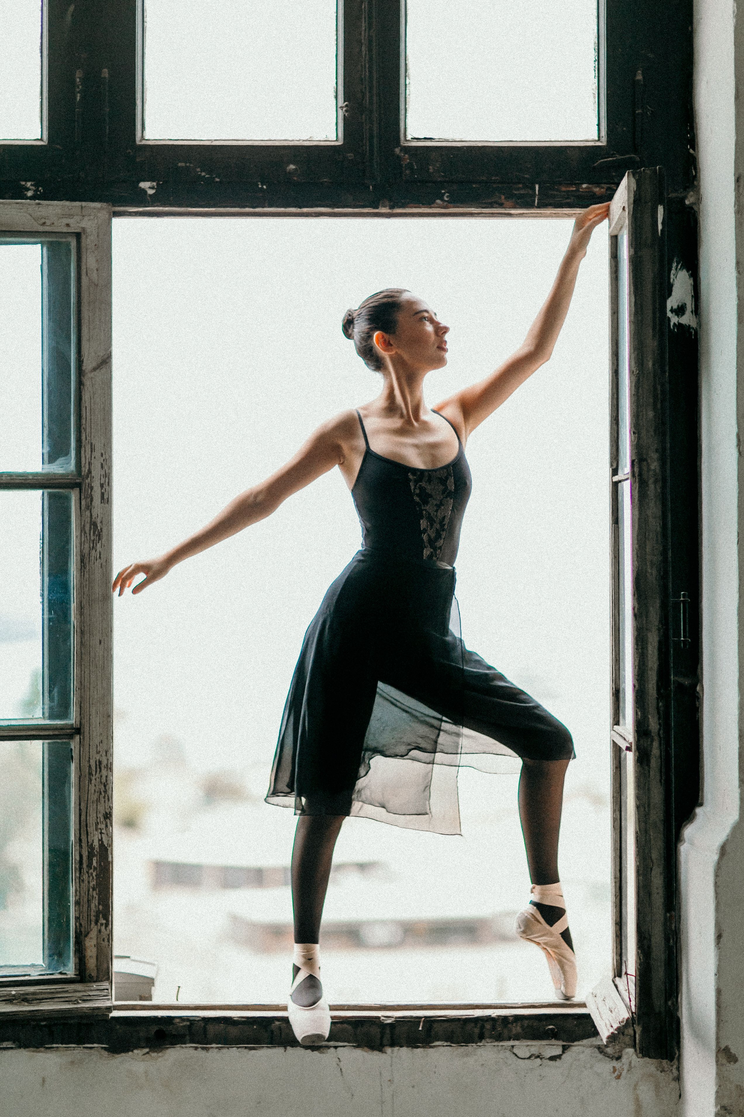 Photo of a Woman Posing against an Open Window · Free Stock Photo