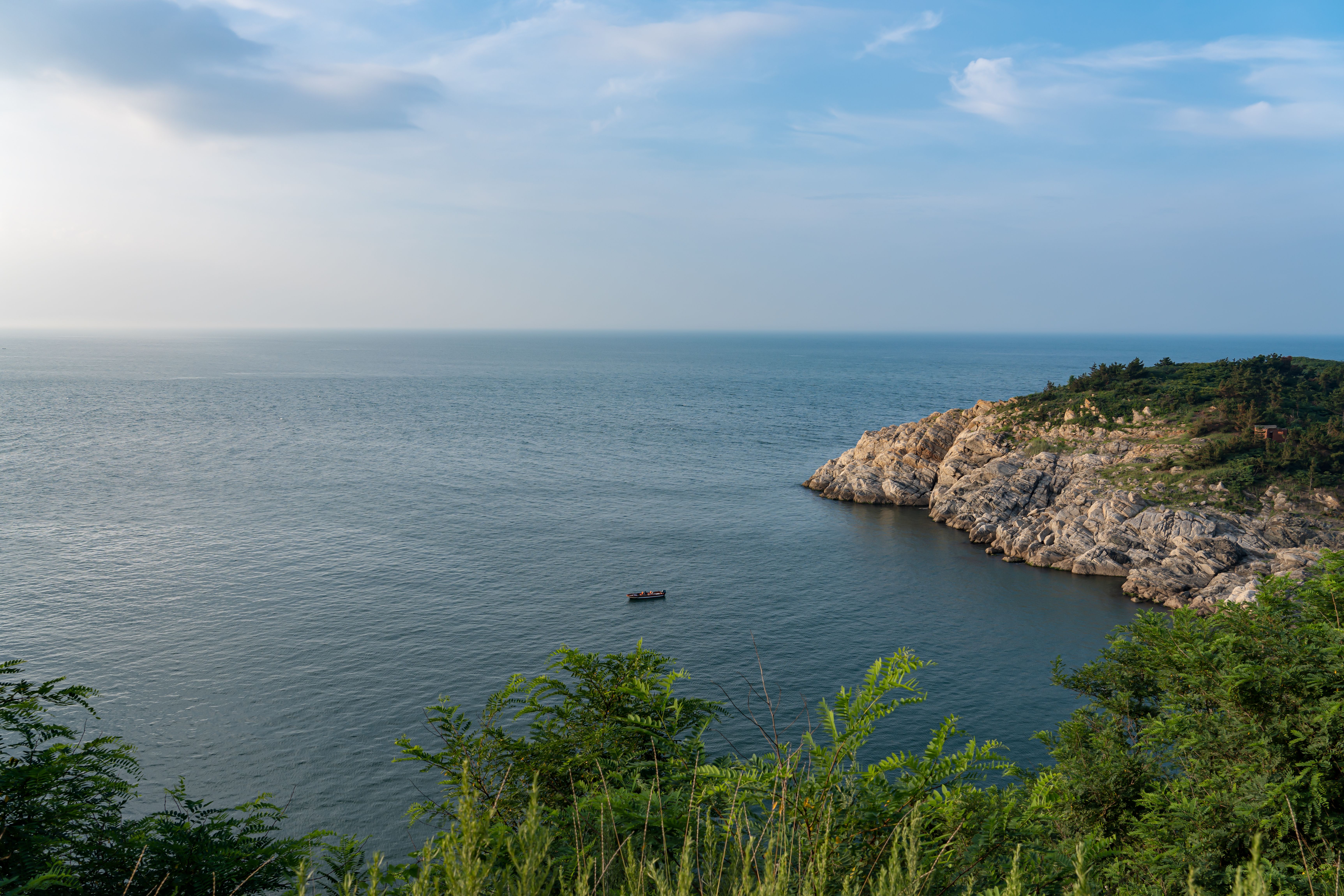 Boat Anchored by Rocky Cliff · Free Stock Photo